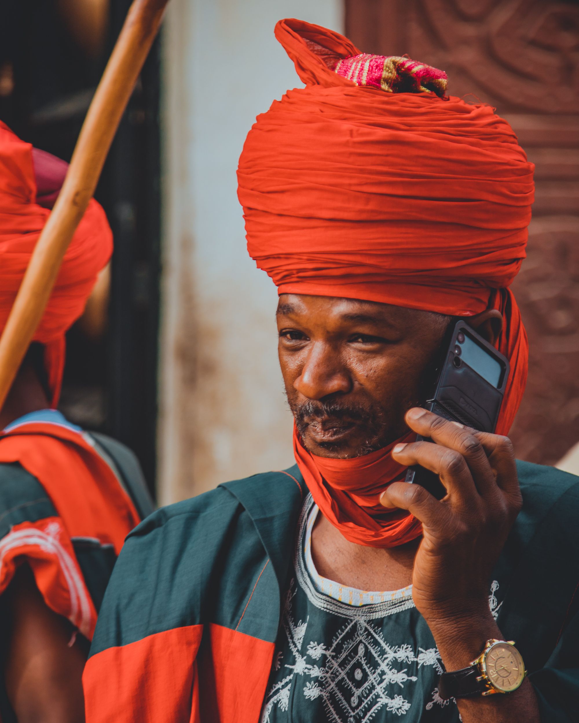 Man in Traditional Nigerian Attire Using Phone · Free Stock Photo