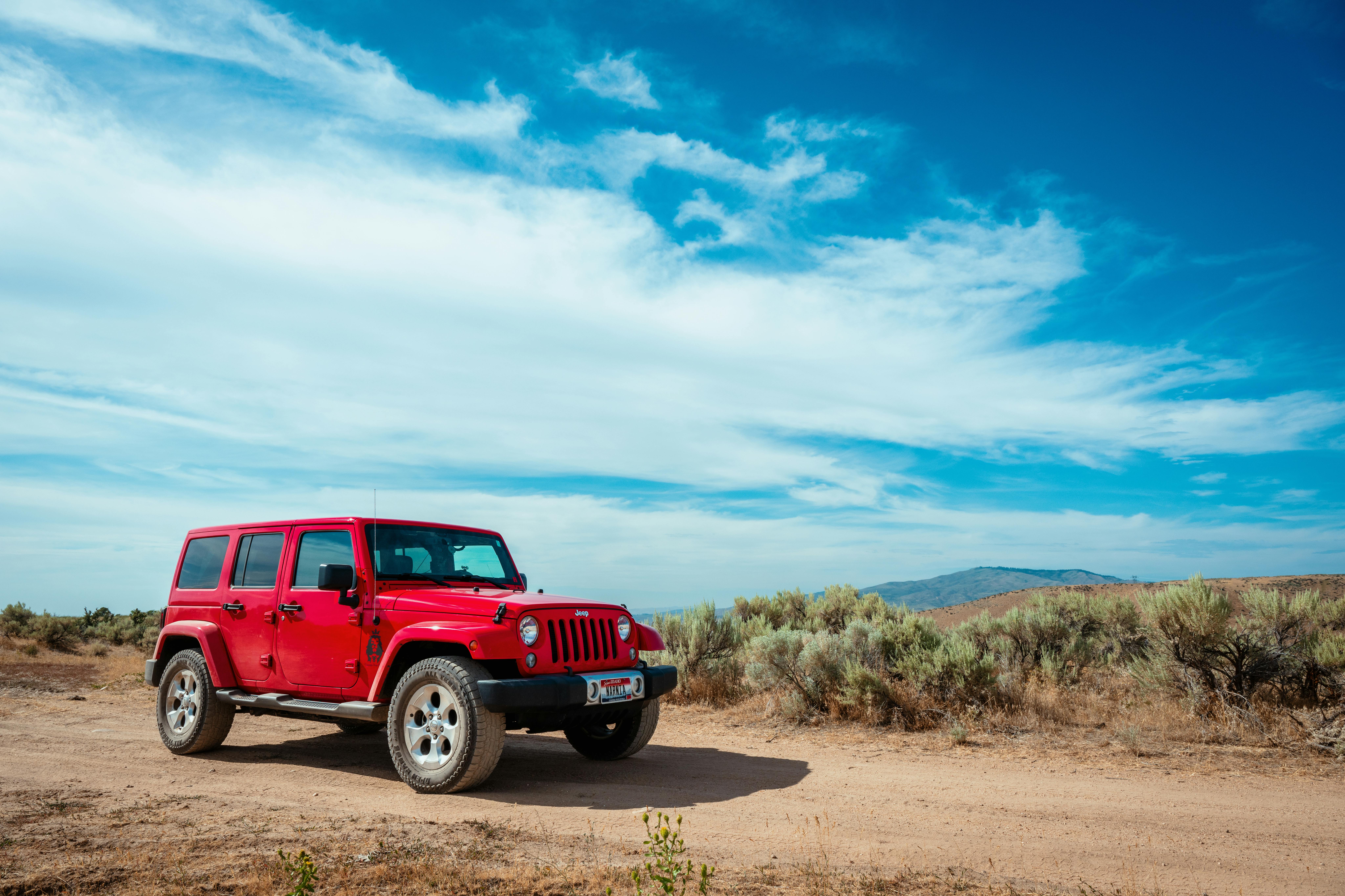 Photo of Red SUV On Dirt Road · Free Stock Photo