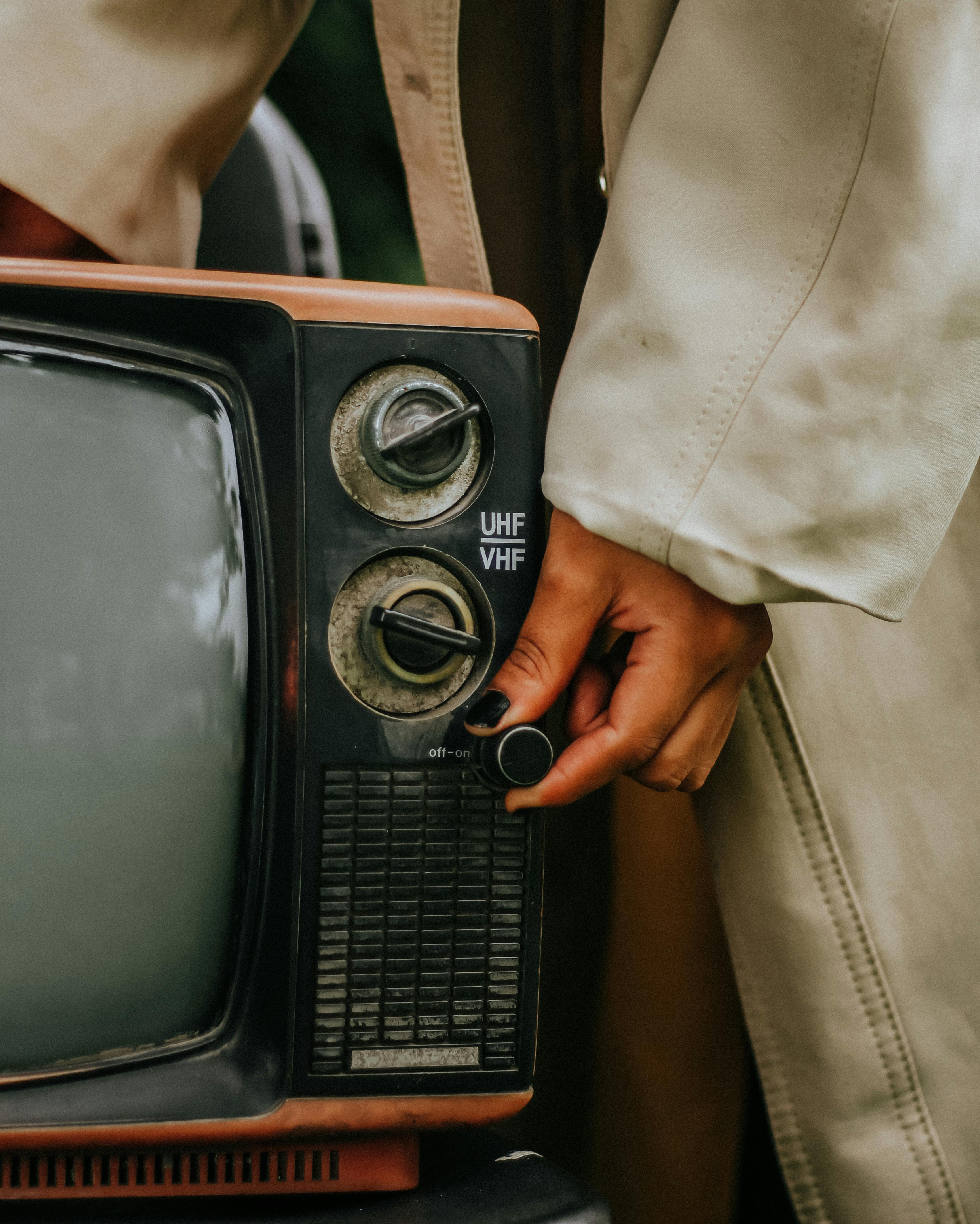 Vintage TV with Person Adjusting Controls · Free Stock Photo