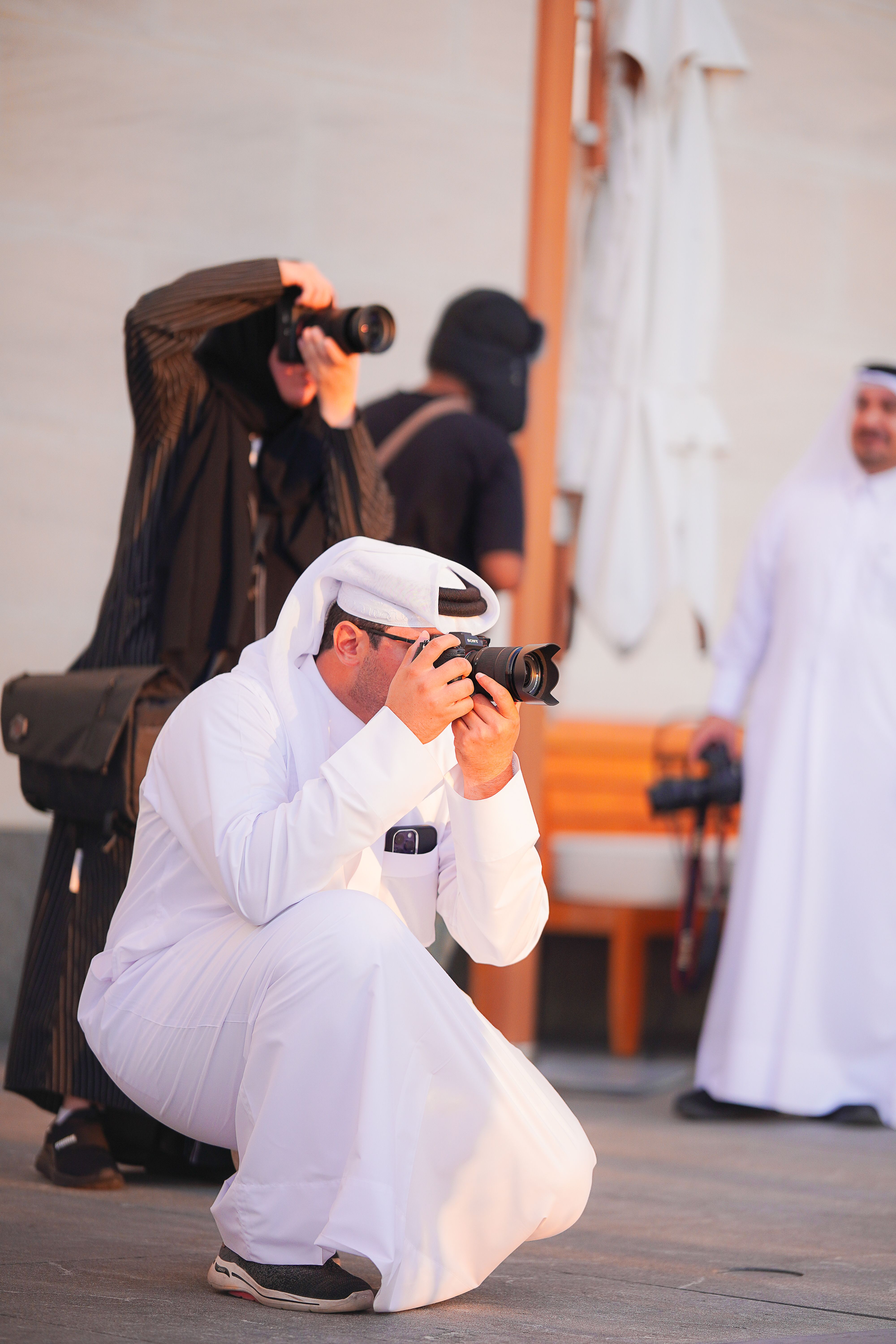 Photographers in Traditional Clothing Capturing Moments · Free Stock Photo