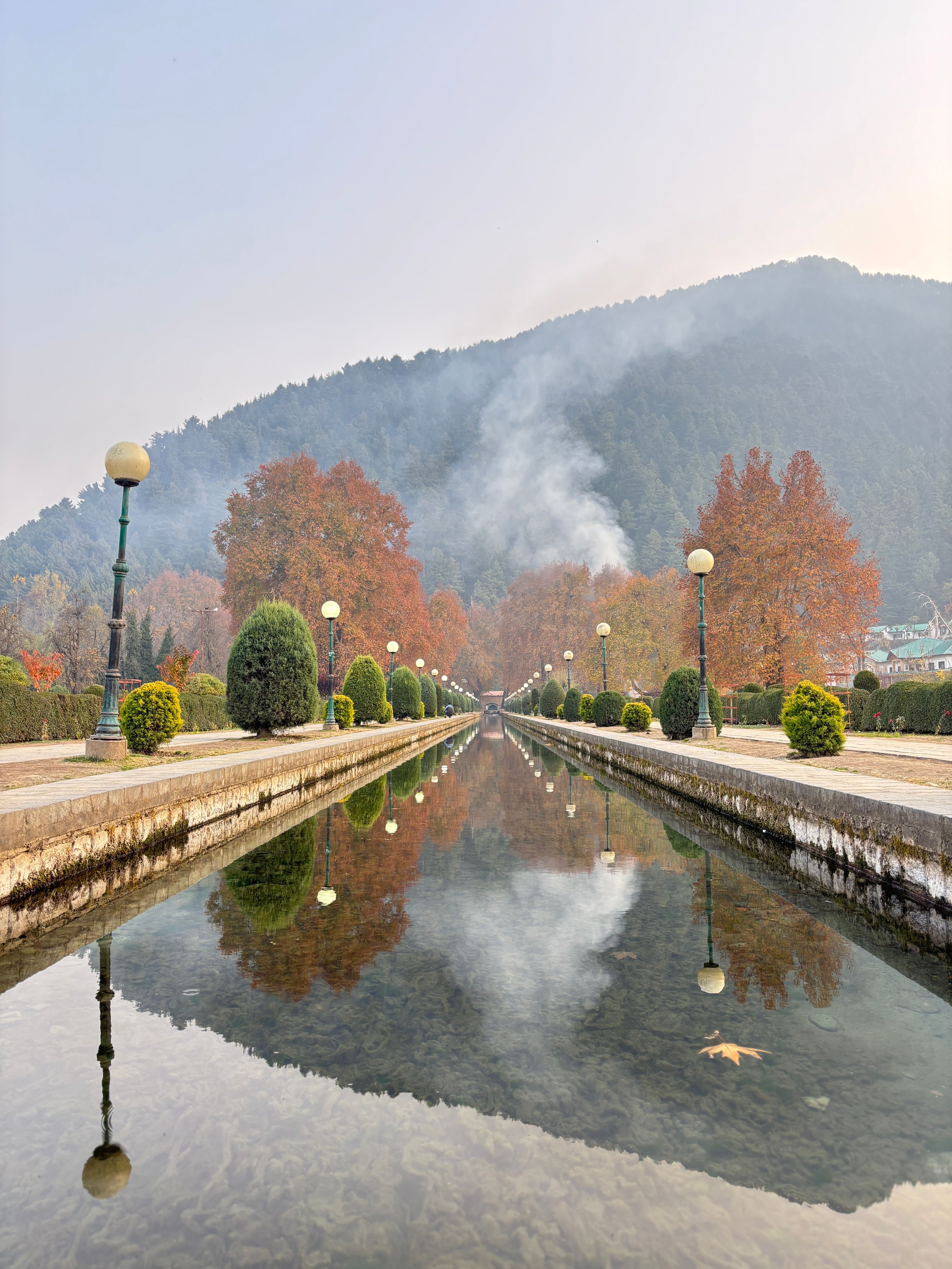 Serene Autumn in Verinag with Reflective Pool · Free Stock Photo