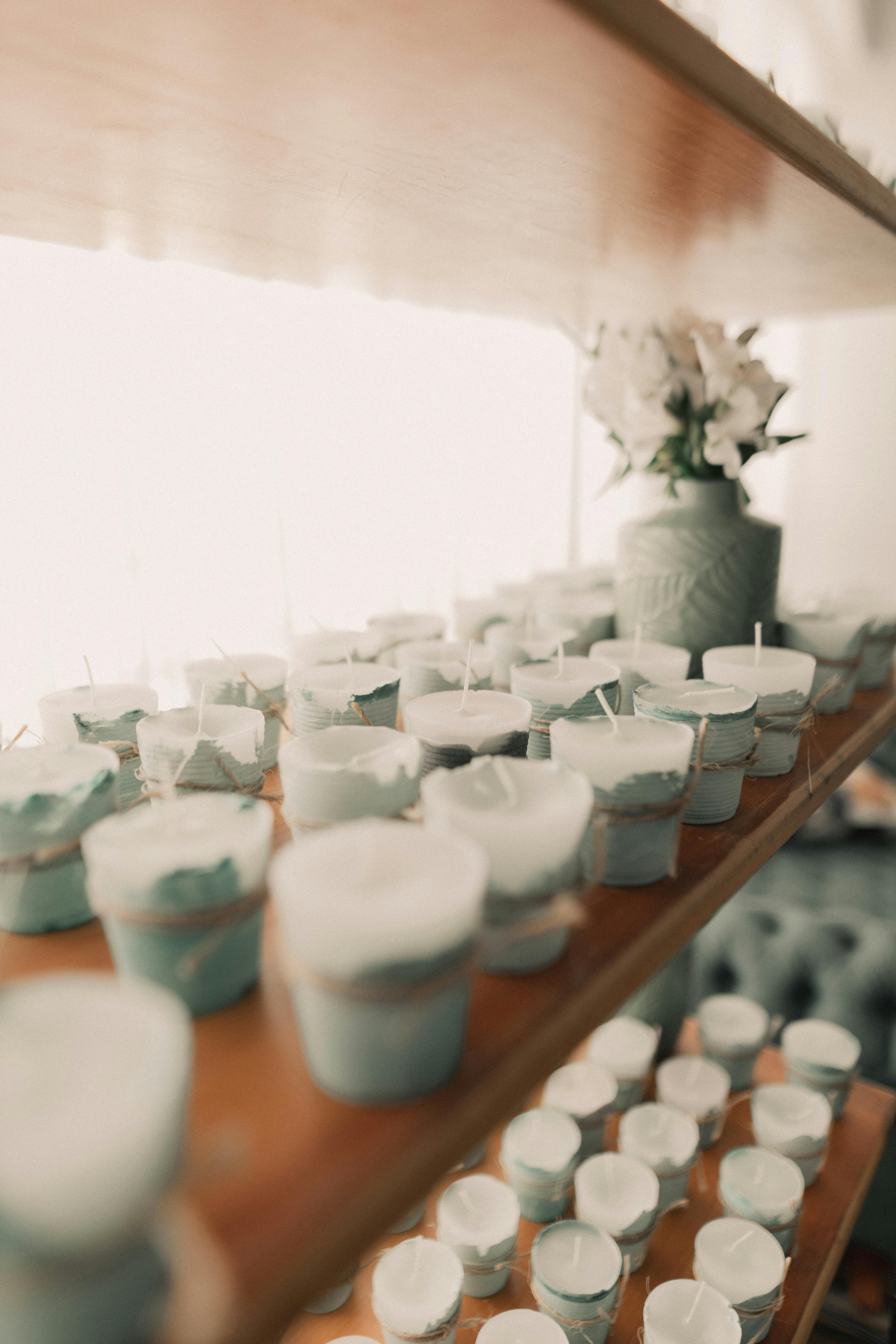 Ceramic Candle Display on Wooden Shelves · Free Stock Photo