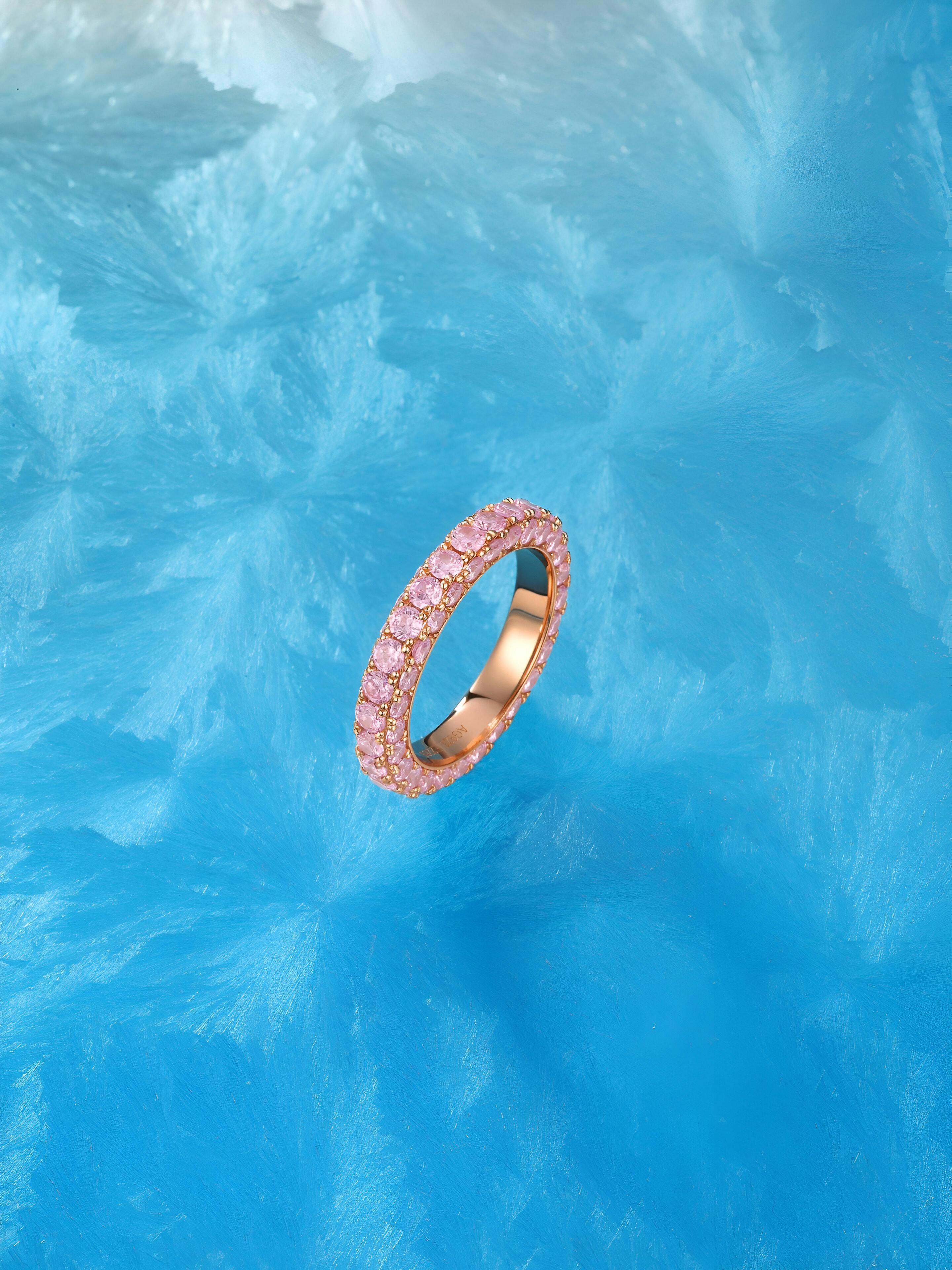Elegant Pink Diamond Eternity Ring on Blue Crystals · Free Stock Photo