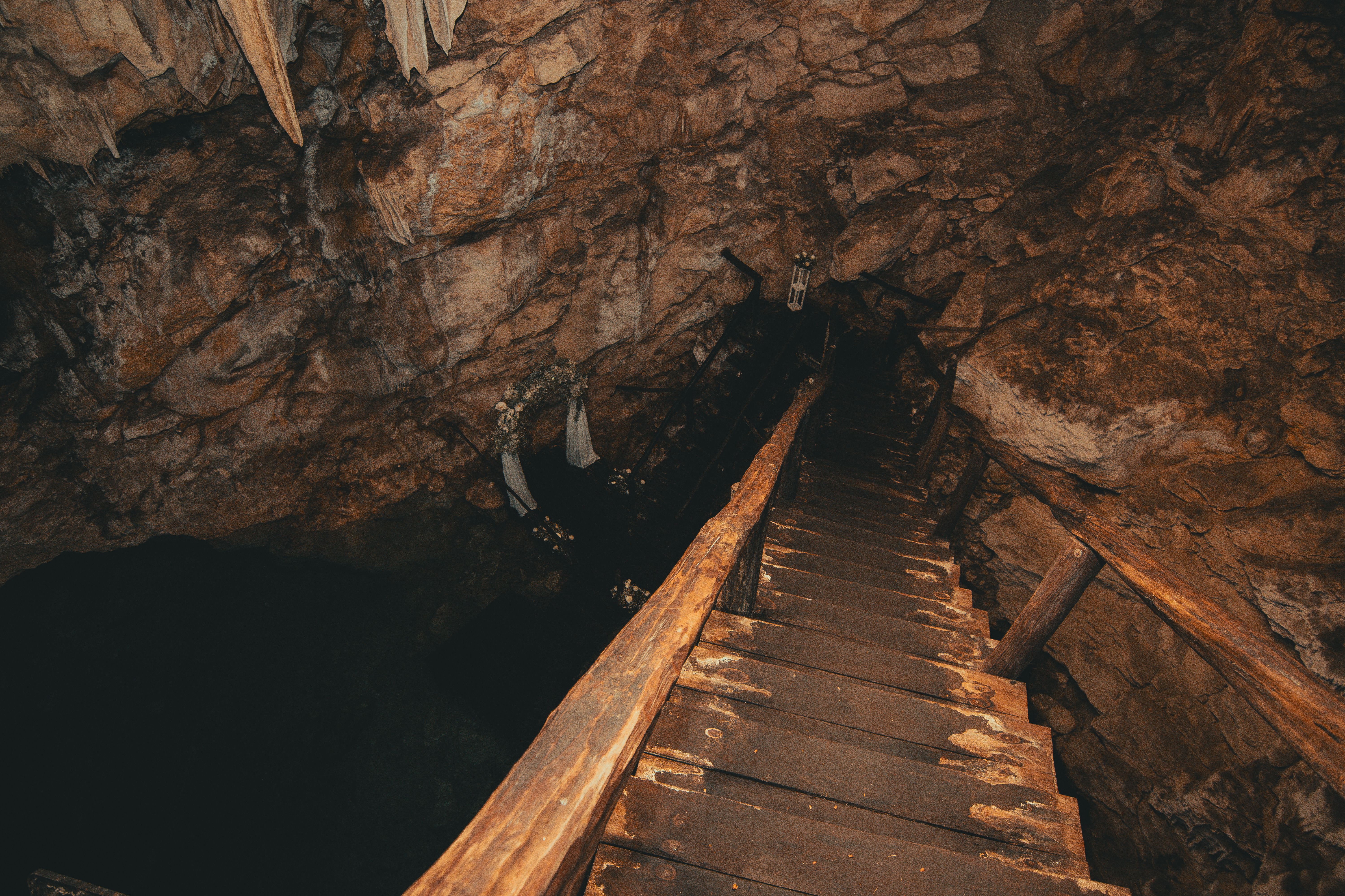 Rustic Wooden Stairs in a Dramatic Cave Interior · Free Stock Photo
