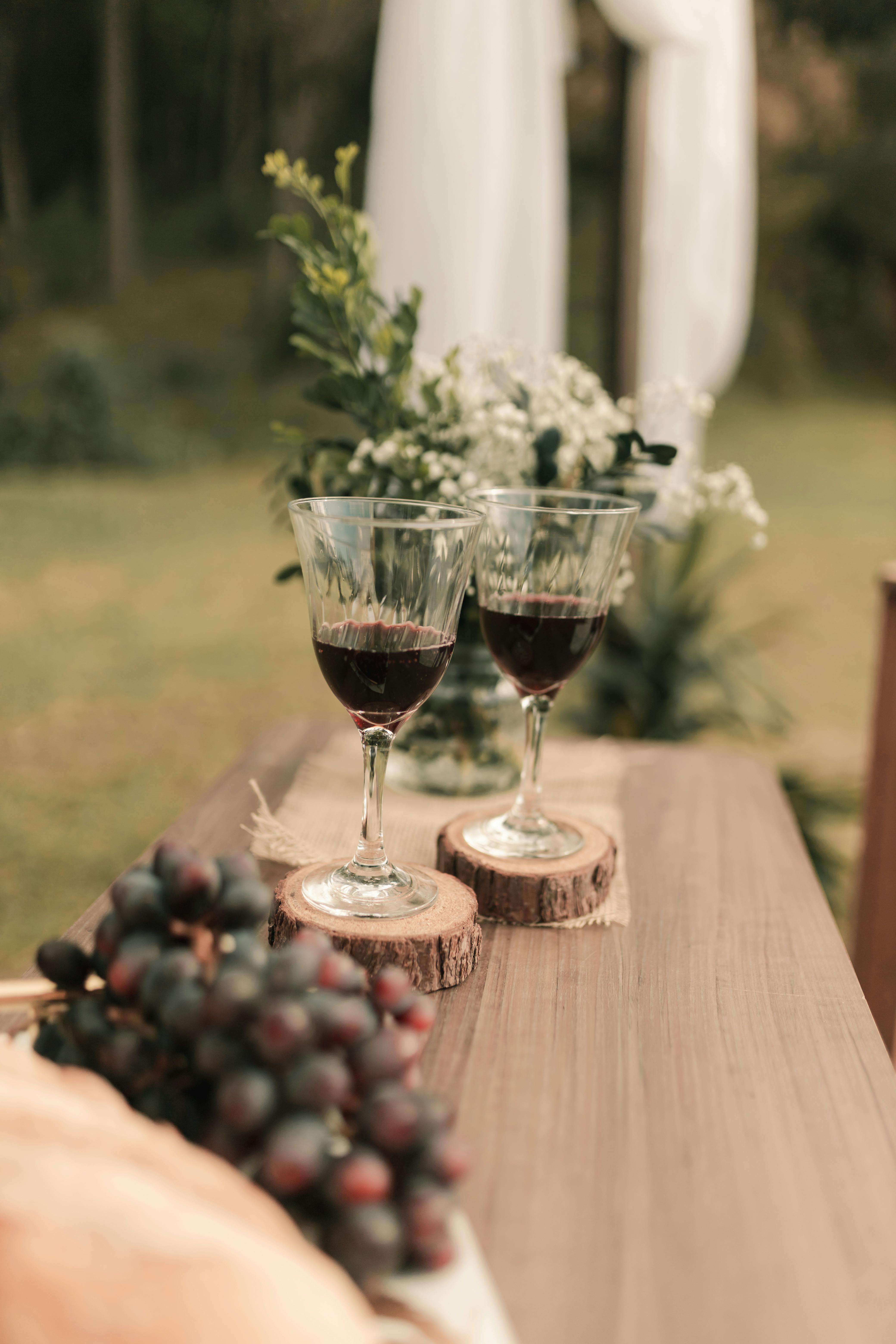 Rustic Outdoor Setting with Red Wine and Grapes · Free Stock Photo