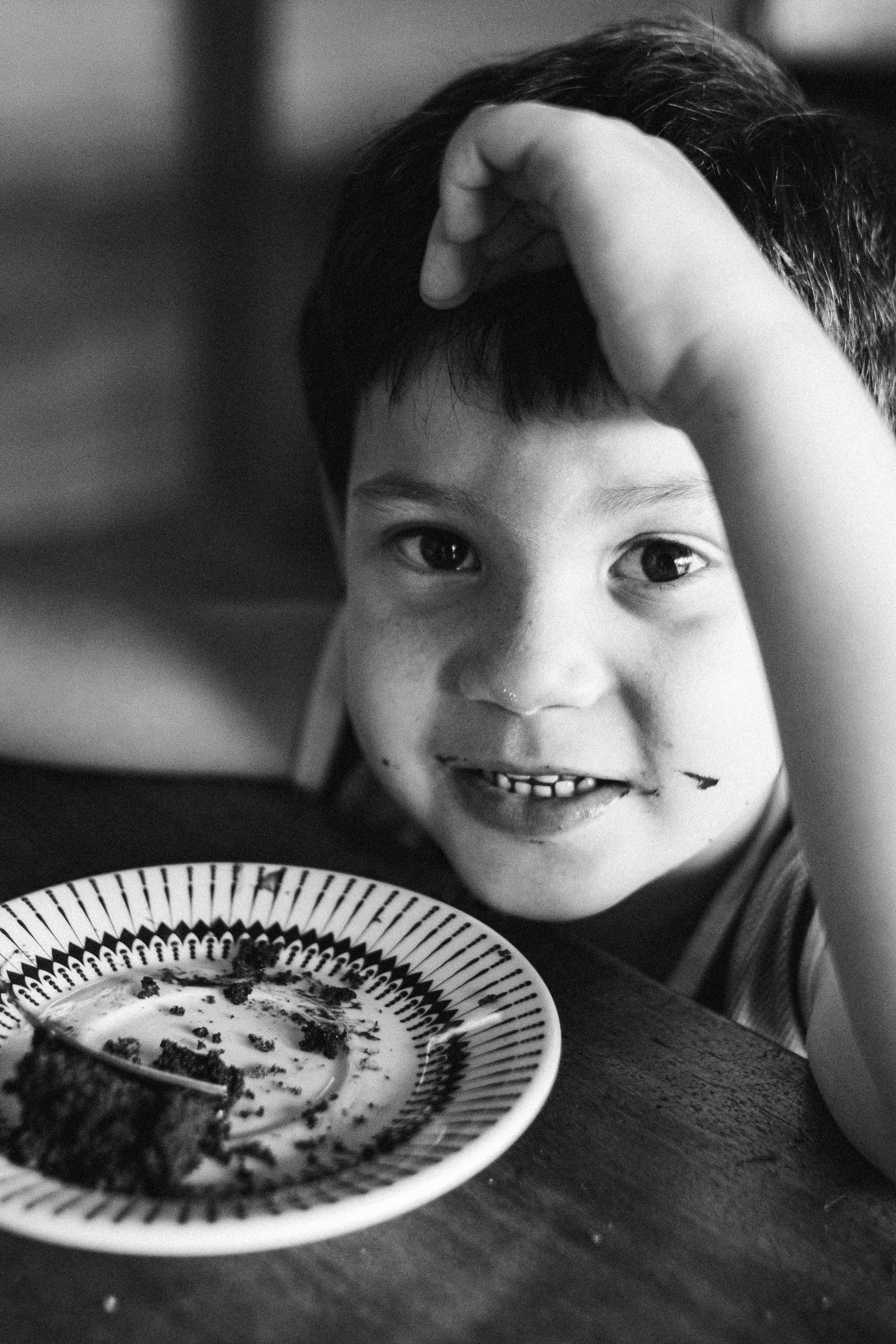Adorable Child Eating Crumb Cake in Black and White · Free Stock Photo