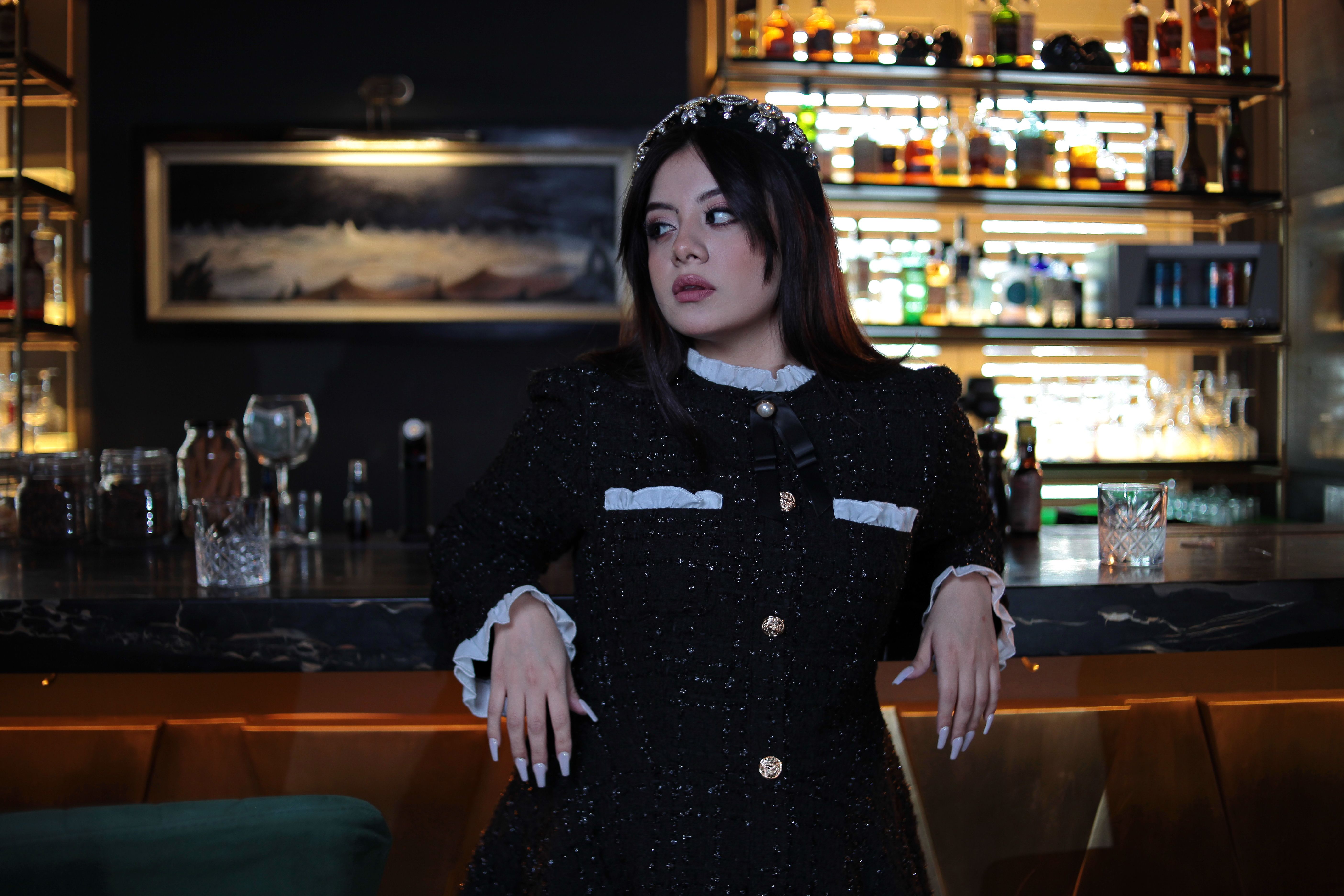 Elegant Woman in Black Tweed at Modern Bar · Free Stock Photo