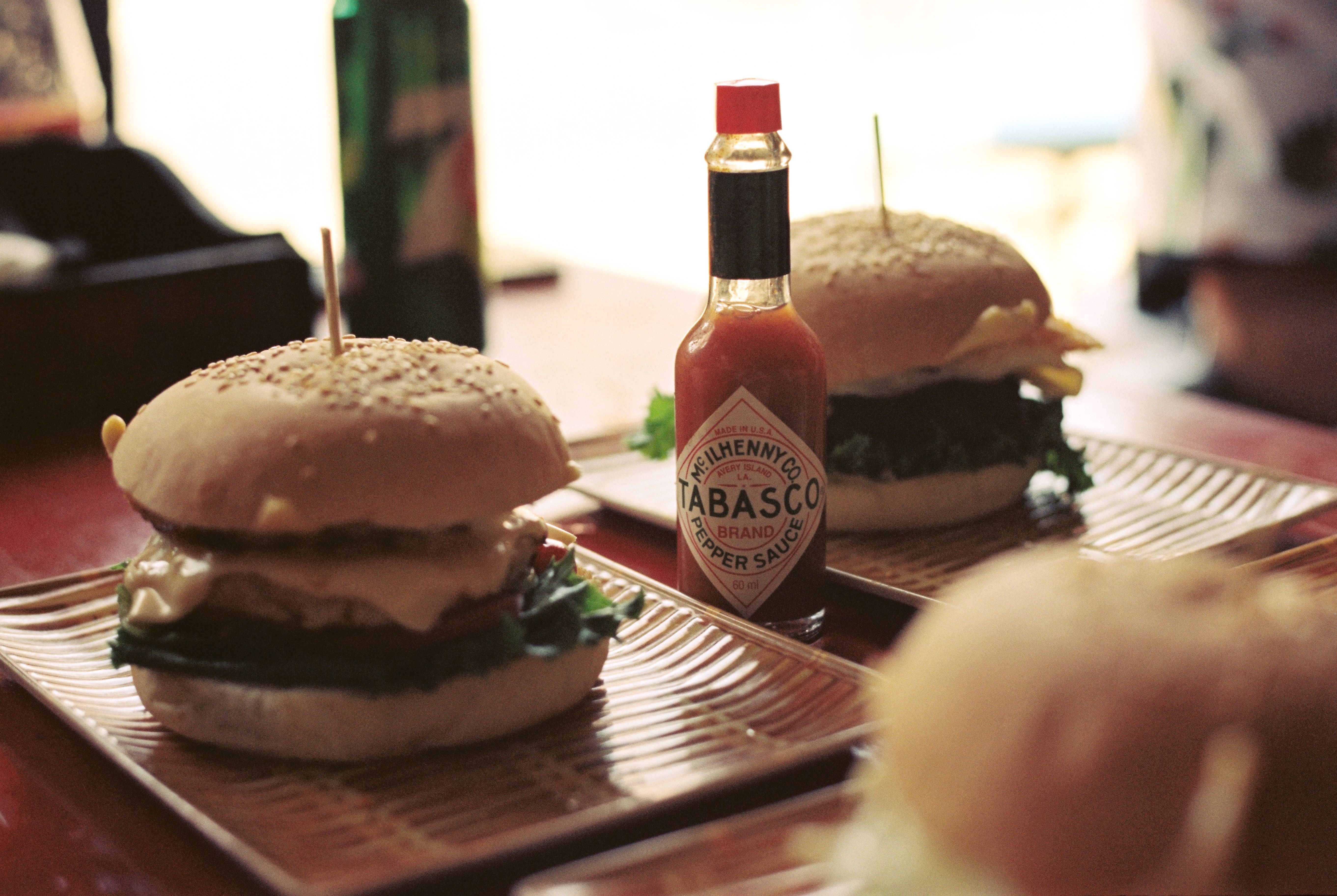 Gourmet Burgers with Tabasco Sauce Display · Free Stock Photo