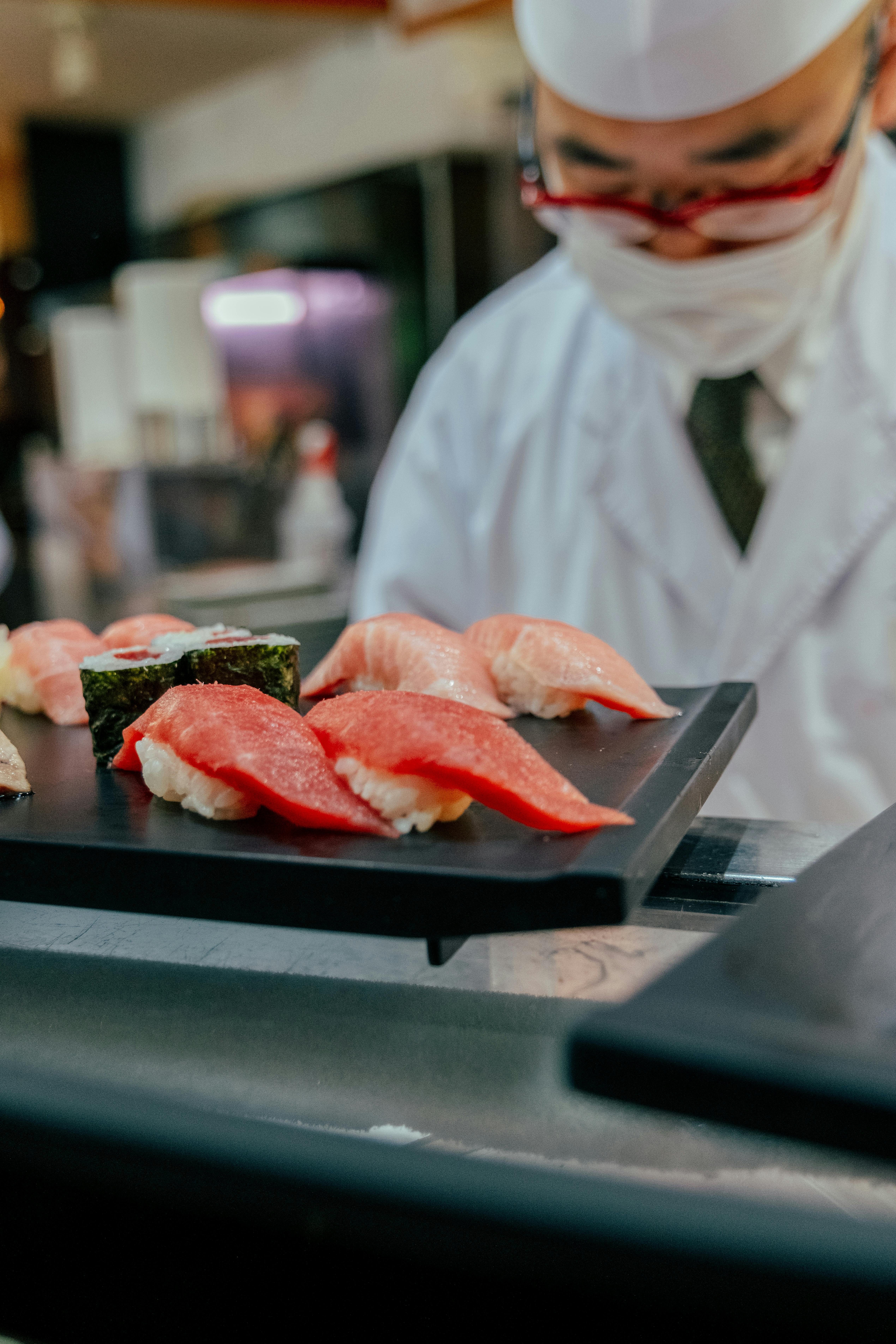 Chef Presenting Sushi Platter in Tokyo Restaurant · Free Stock Photo