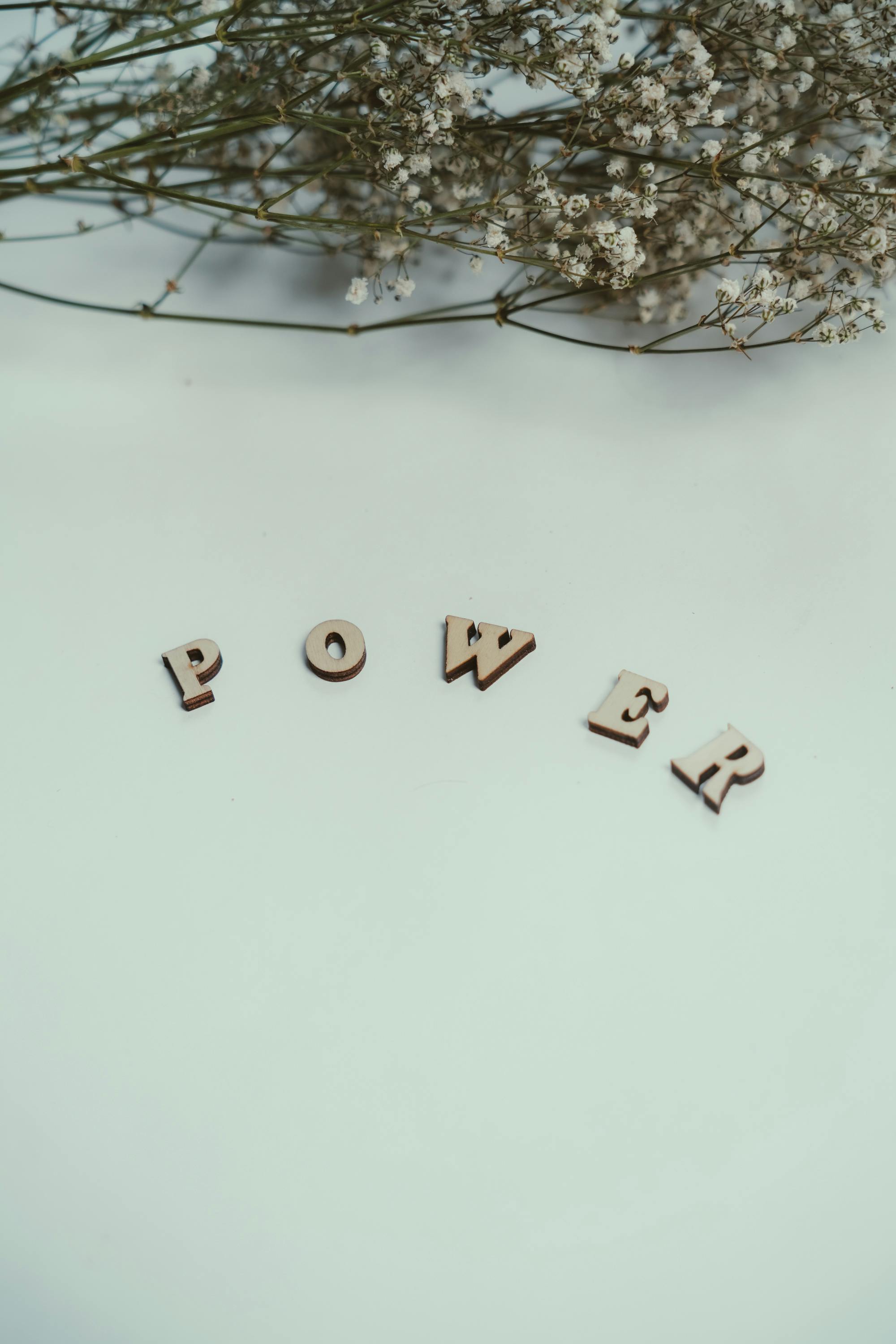 Wooden Letters Spell 'Power' with Floral Accent · Free Stock Photo