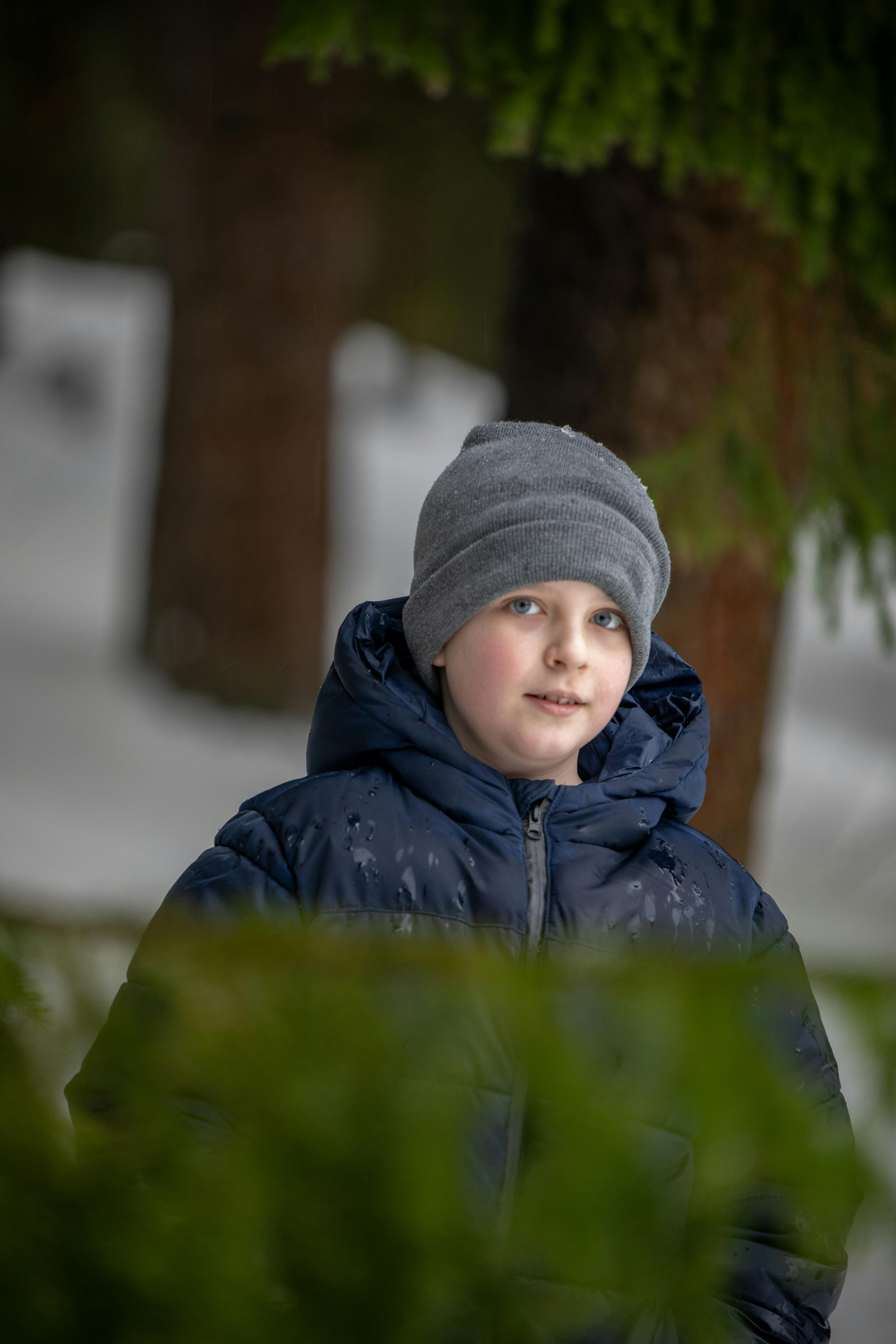 Portrait of a Boy in Winter Clothing Outdoors · Free Stock Photo