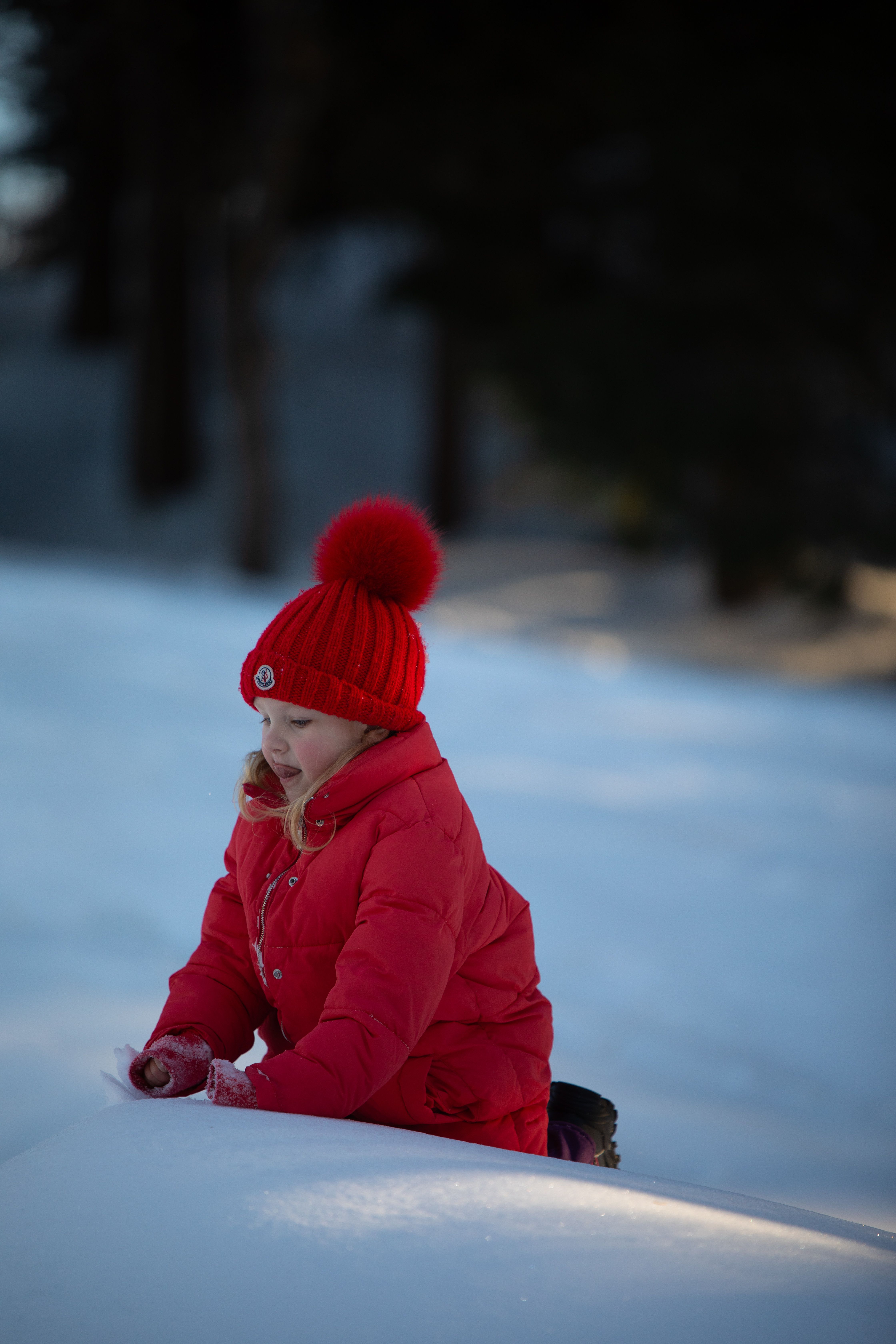 Child in Red Coat Playing in Winter Snow · Free Stock Photo