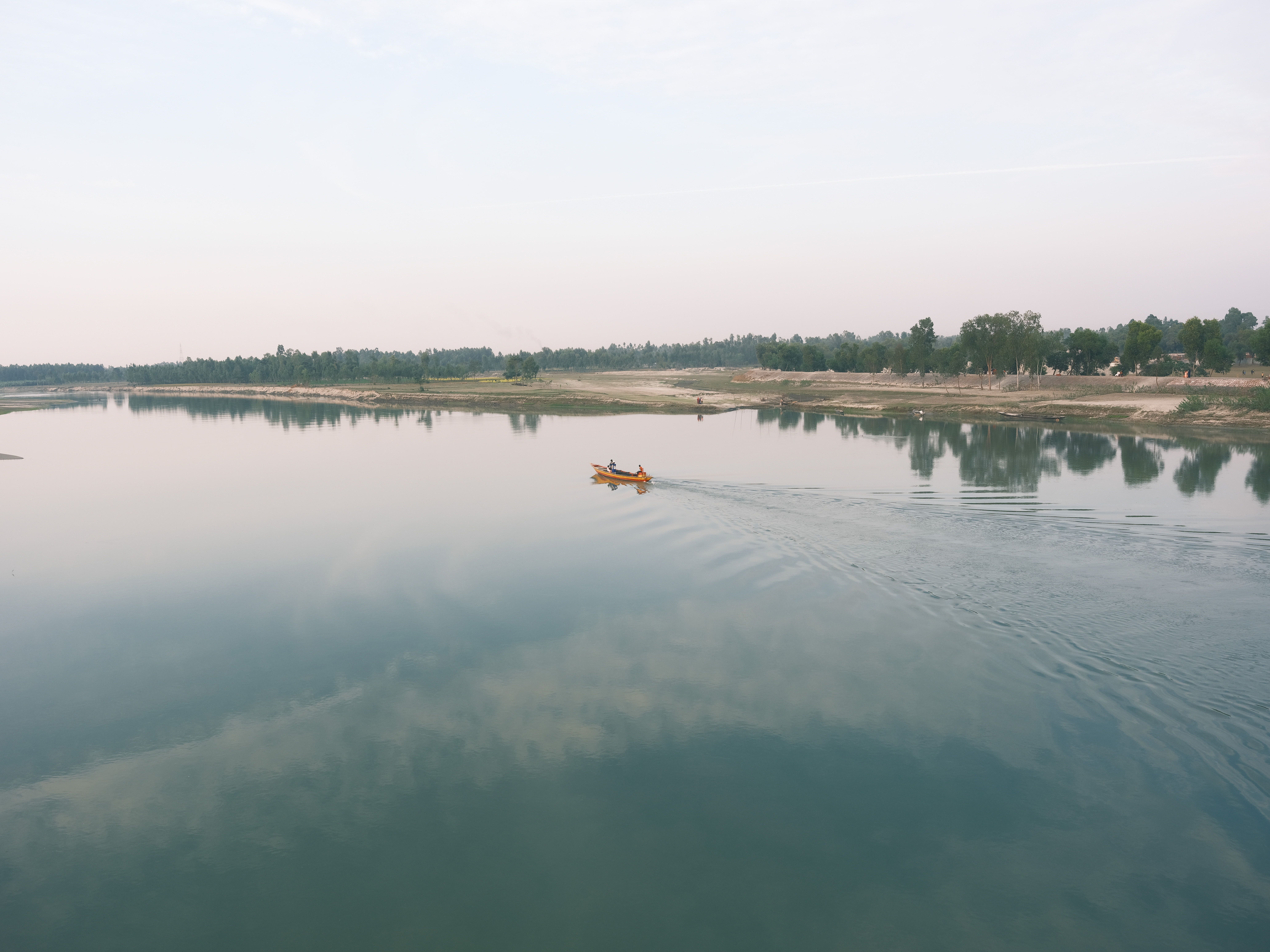 Tranquil Boat Ride on Calm Reflective Lake · Free Stock Photo