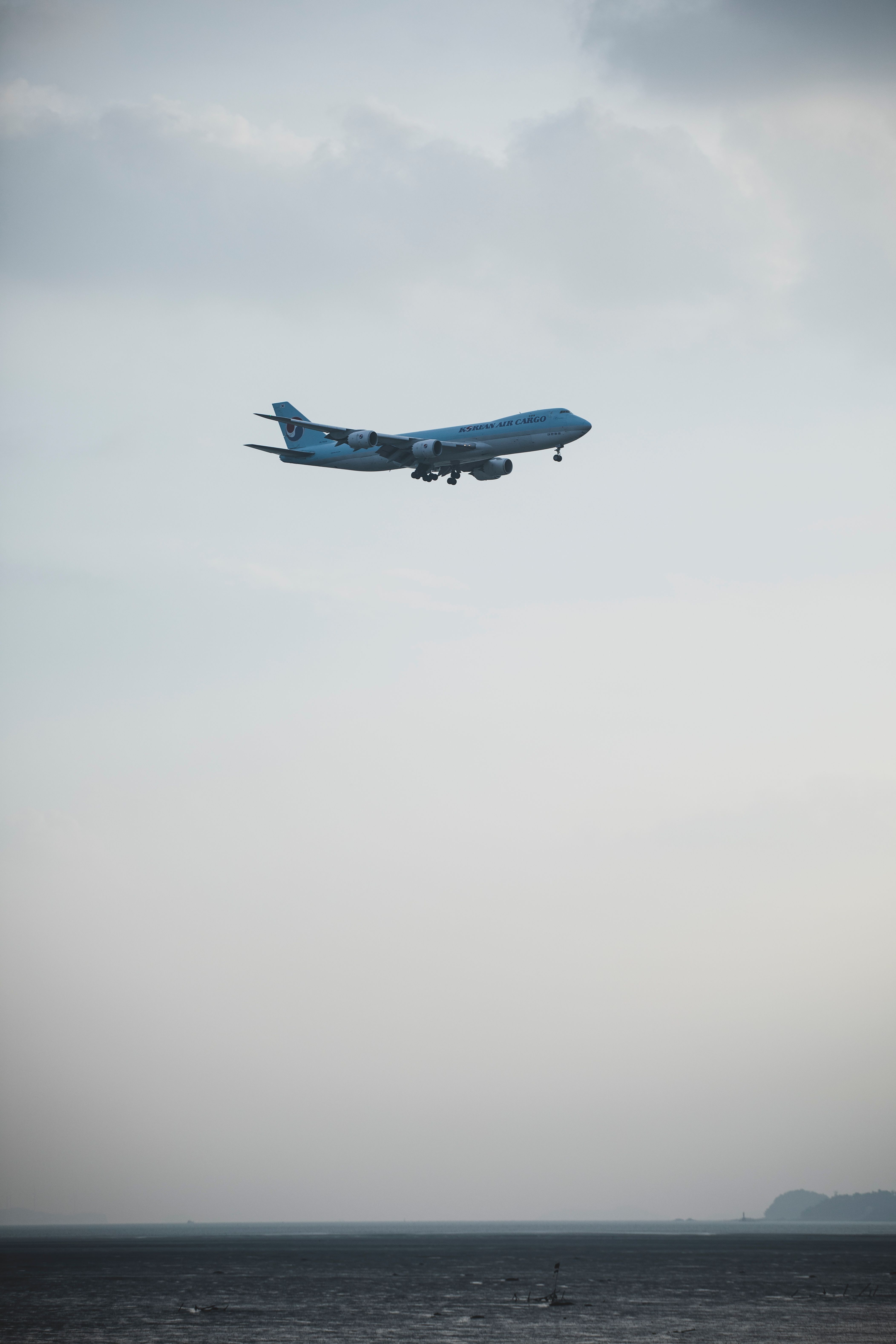 Commercial Airplane Landing Over Ocean · Free Stock Photo