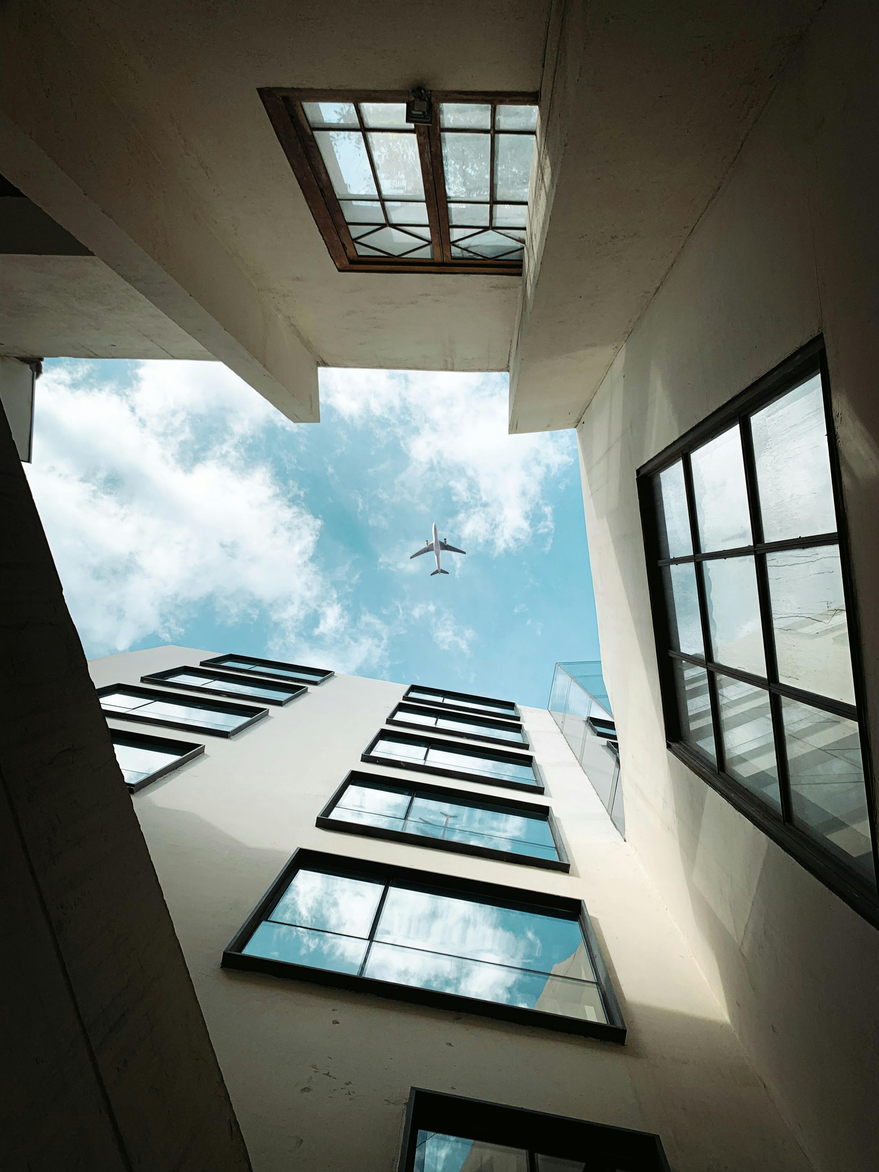 Airplane Flying Over Modern Santiago Architecture · Free Stock Photo