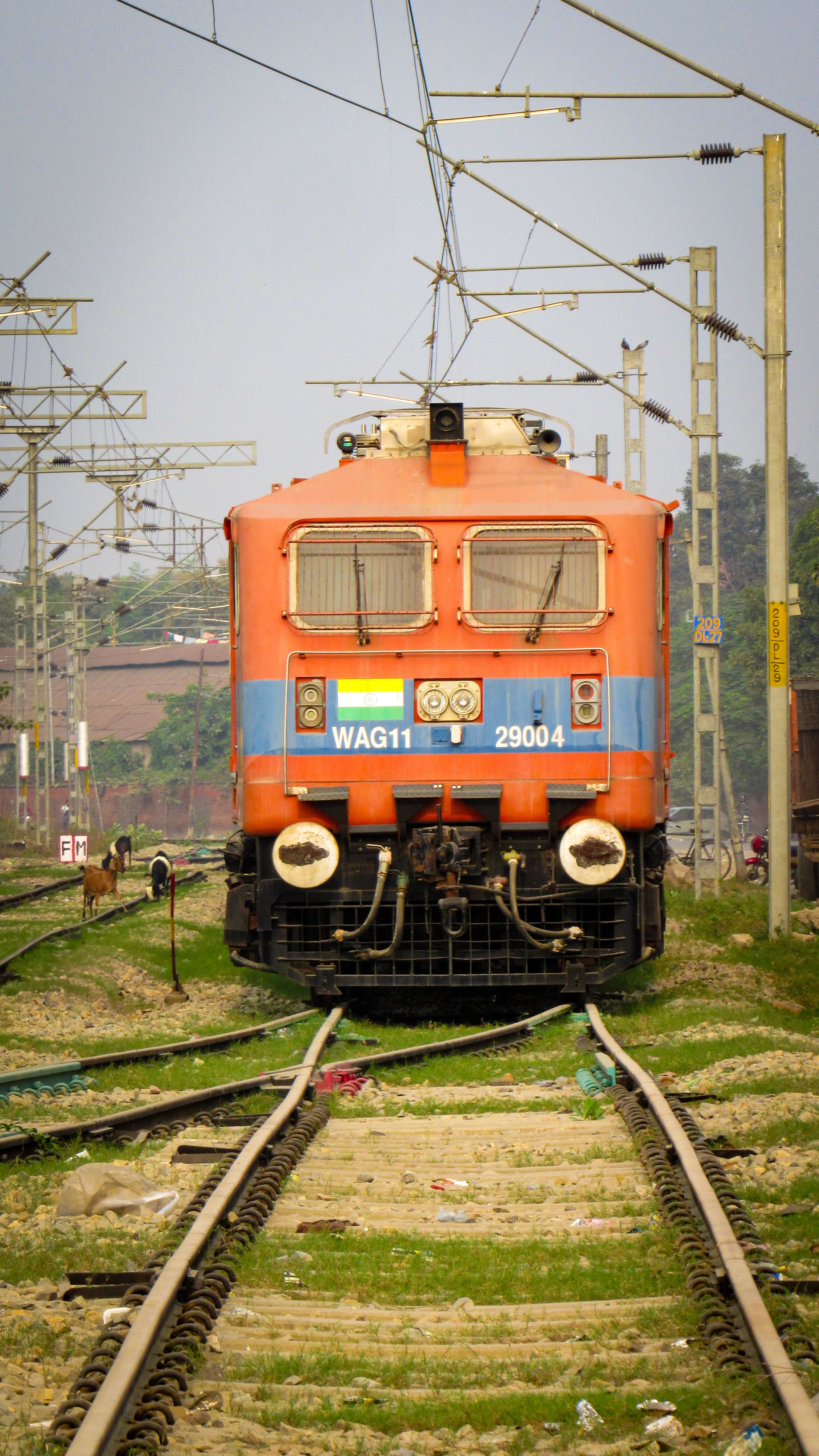 Front View of Orange Electric Train on Tracks · Free Stock Photo