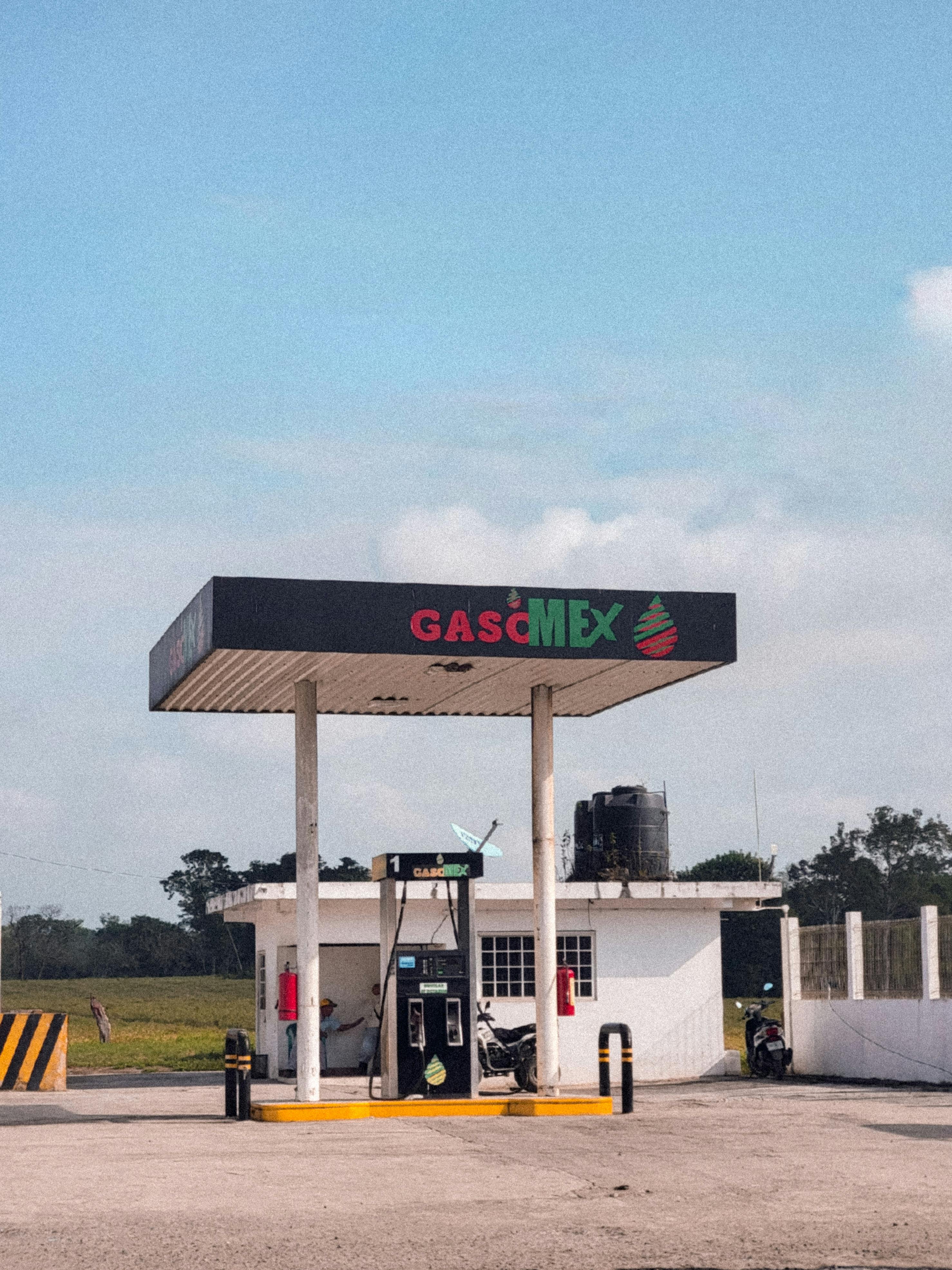 Gas station in rural setting under blue sky · Free Stock Photo