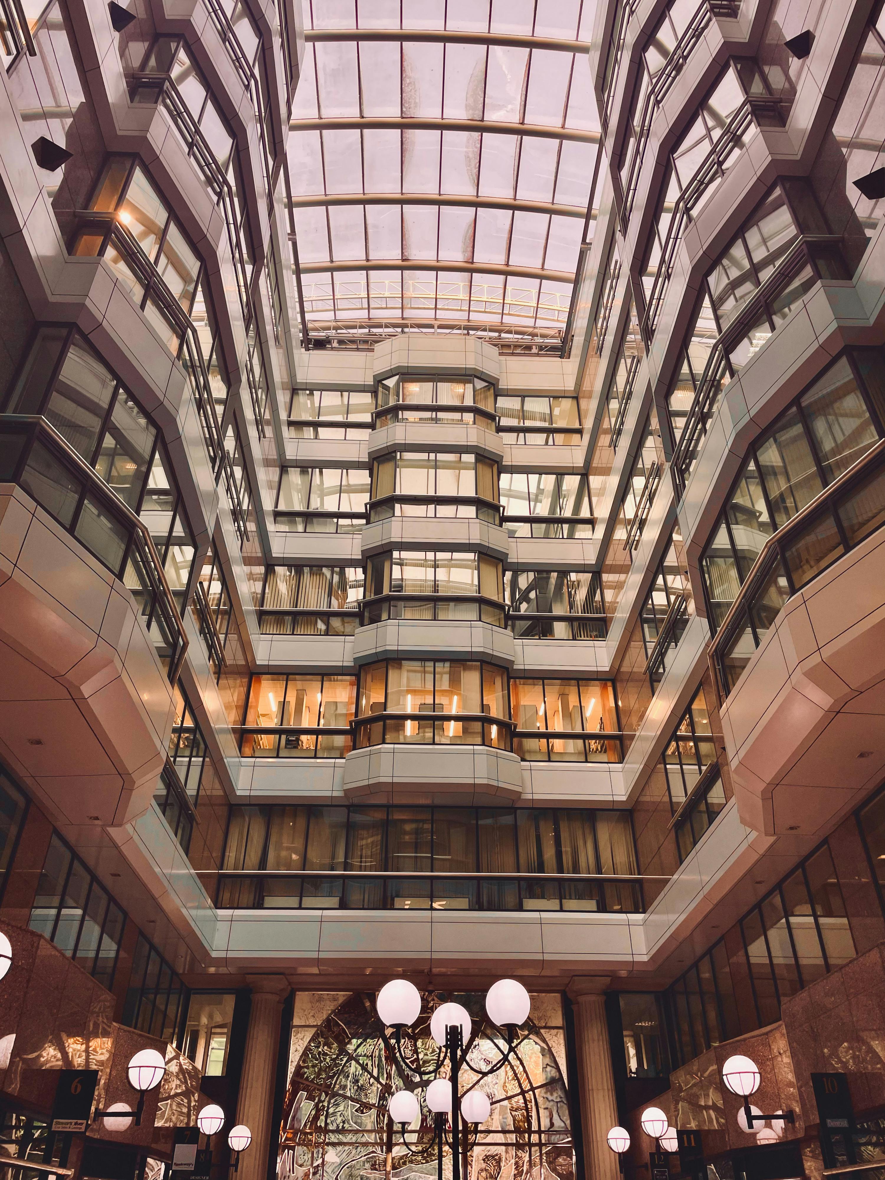 Modern Atrium with Glass Ceiling and Warm Lighting · Free Stock Photo