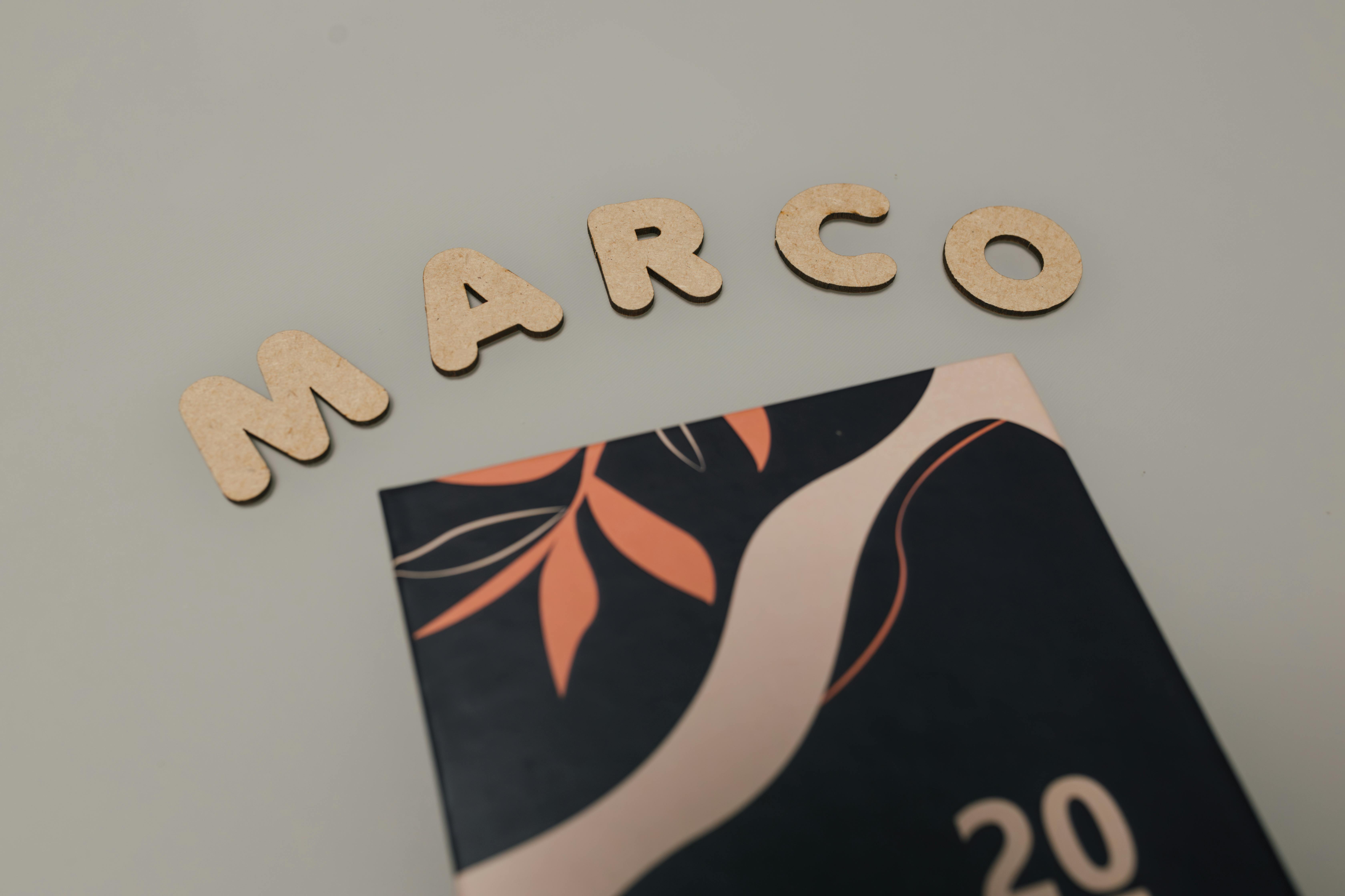 Wooden Letters Spelling 'MARCO' on Artistic Notebook · Free Stock Photo