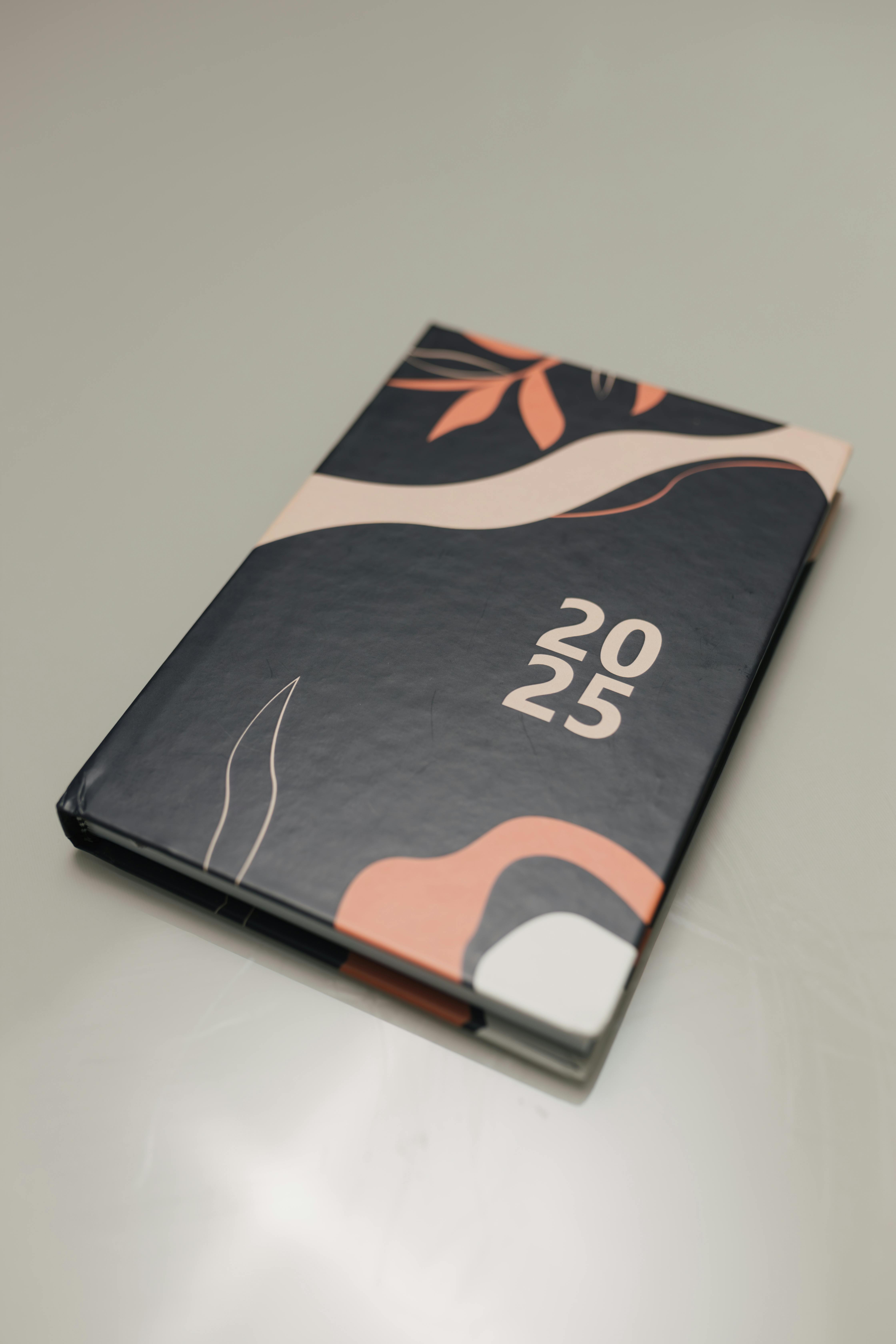 Stylish 2025 Planner with Abstract Cover Design · Free Stock Photo