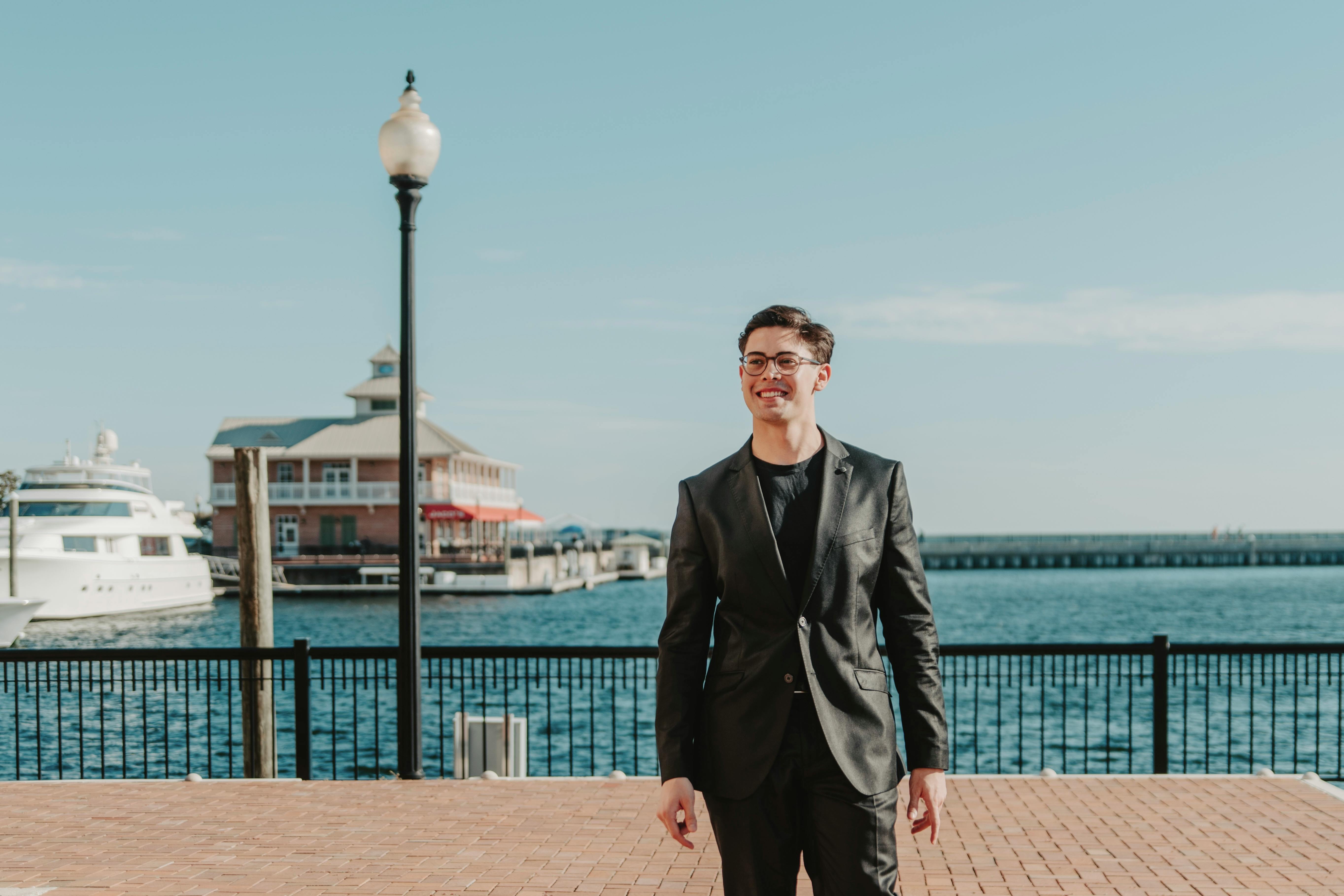 Man in Suit Smiling by Marina with Boats · Free Stock Photo