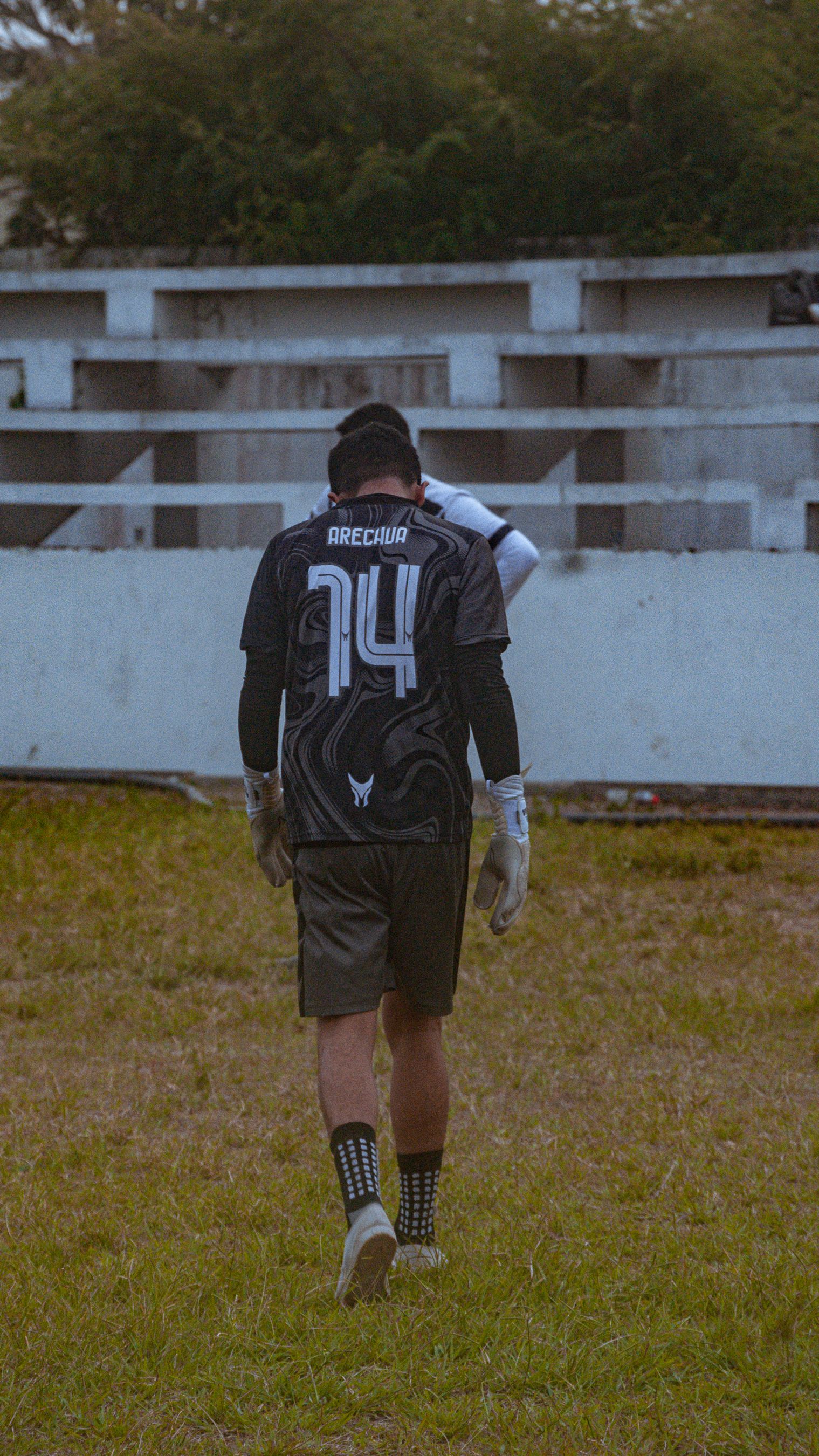 Football Player Walking on Field in Uniform · Free Stock Photo