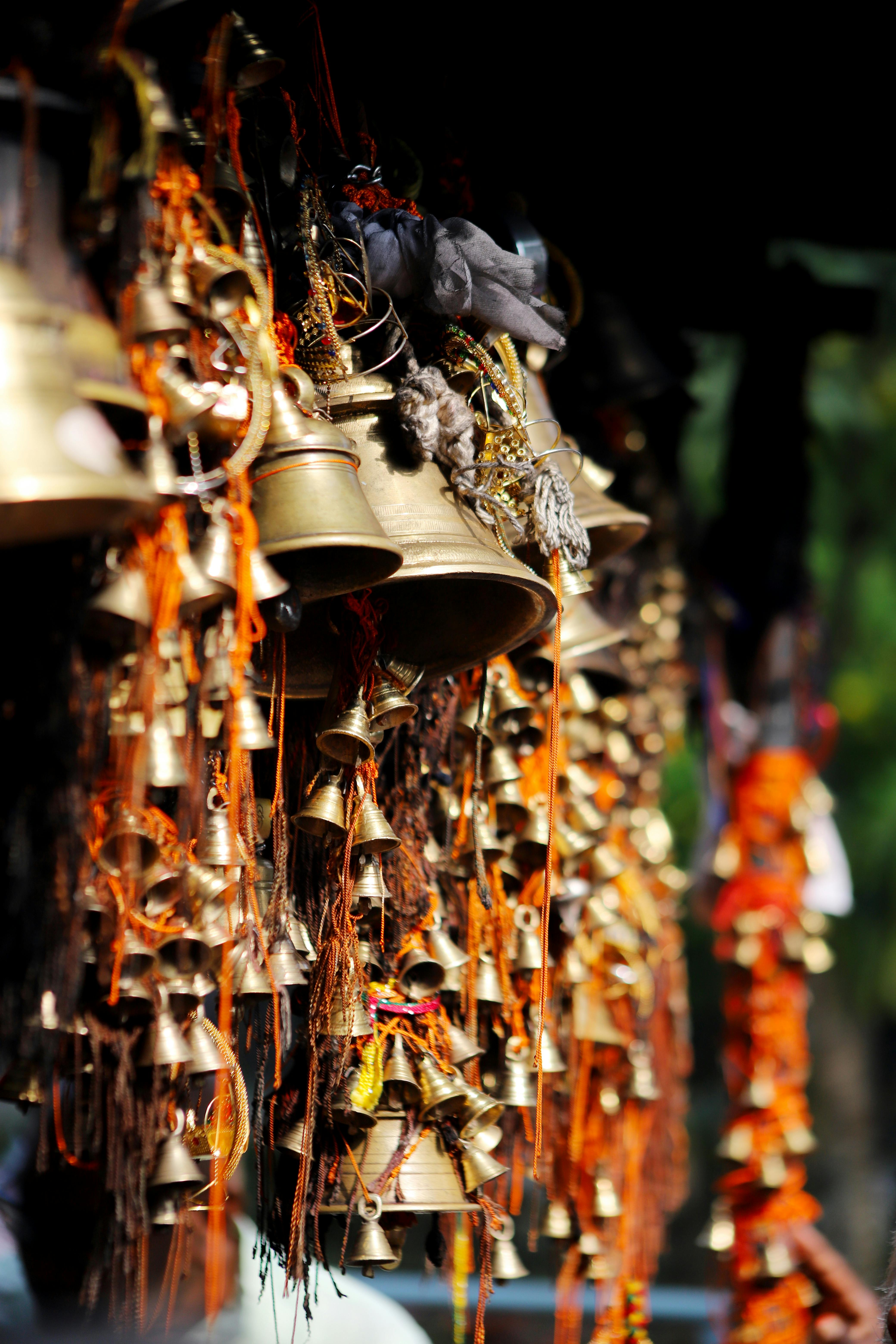 Golden Temple Bells with Colorful Strings · Free Stock Photo