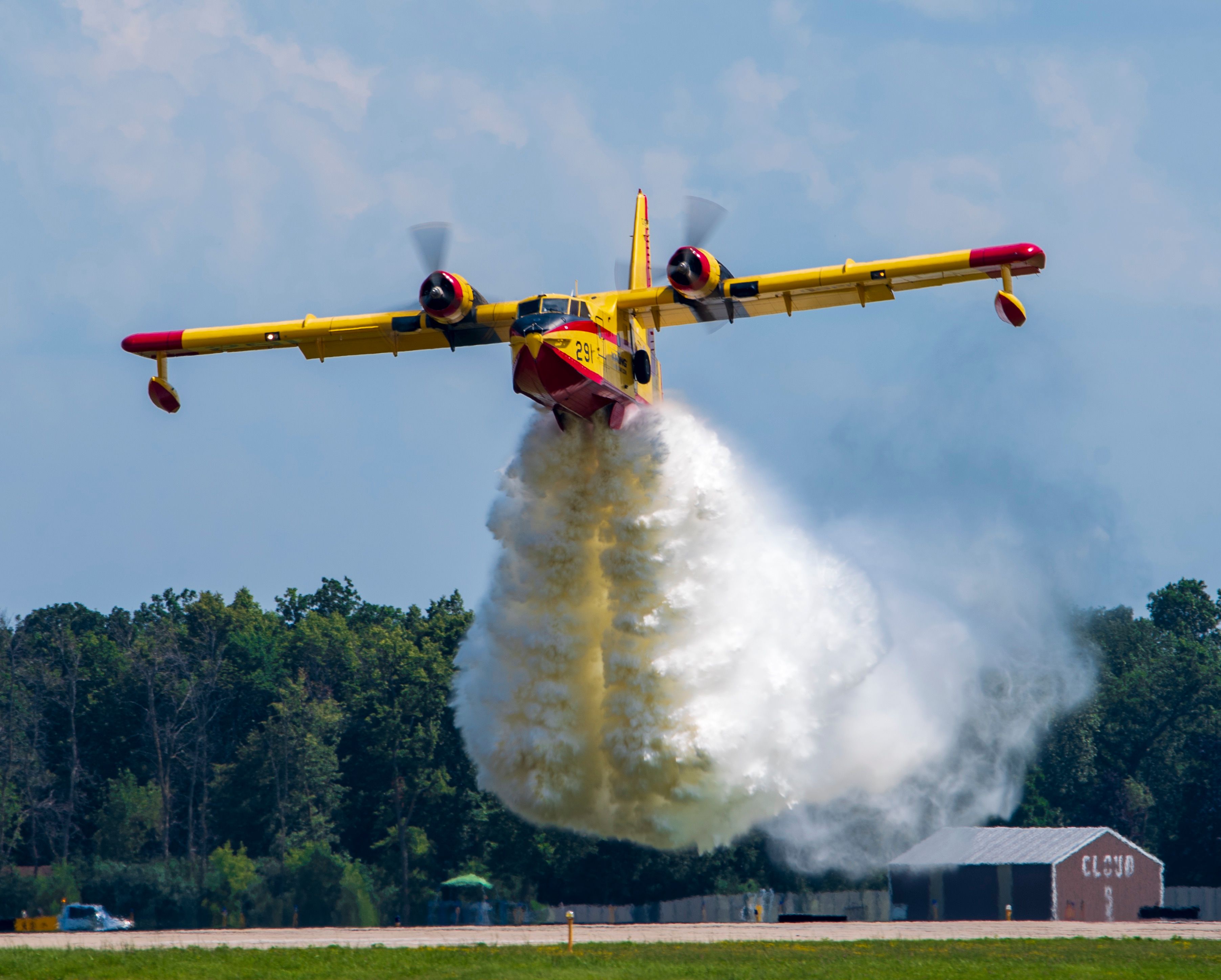 Firefighting Plane Discharging Water Over Forest · Free Stock Photo