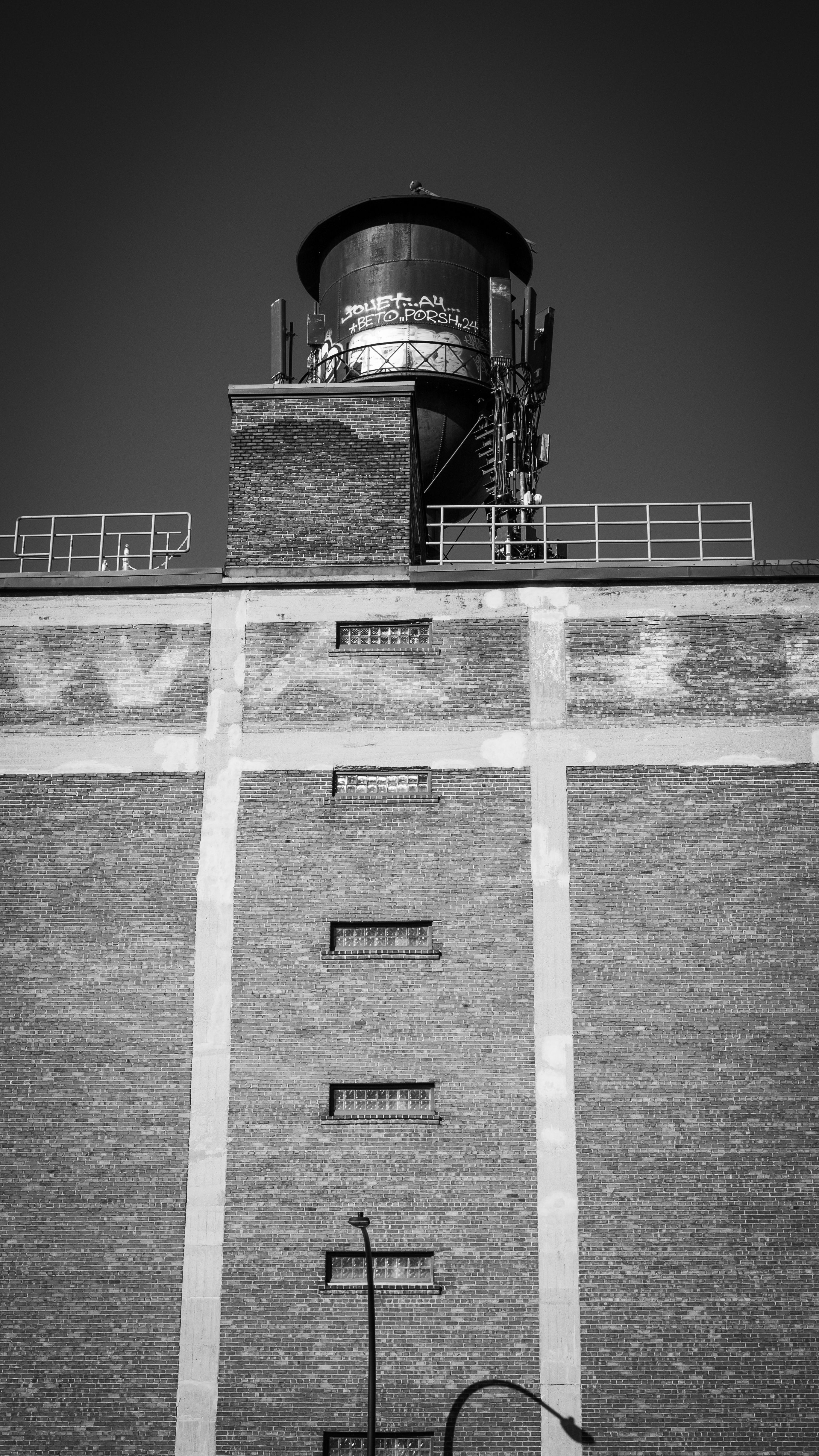Black and White Urban Water Tower Scene · Free Stock Photo