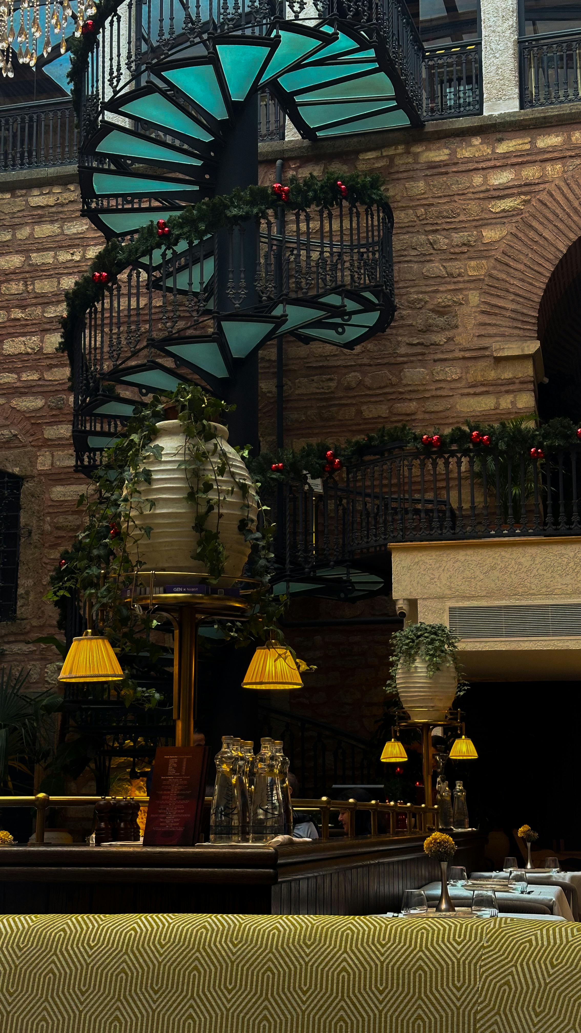 Elegant Spiral Staircase in Cozy Cafe Setting · Free Stock Photo