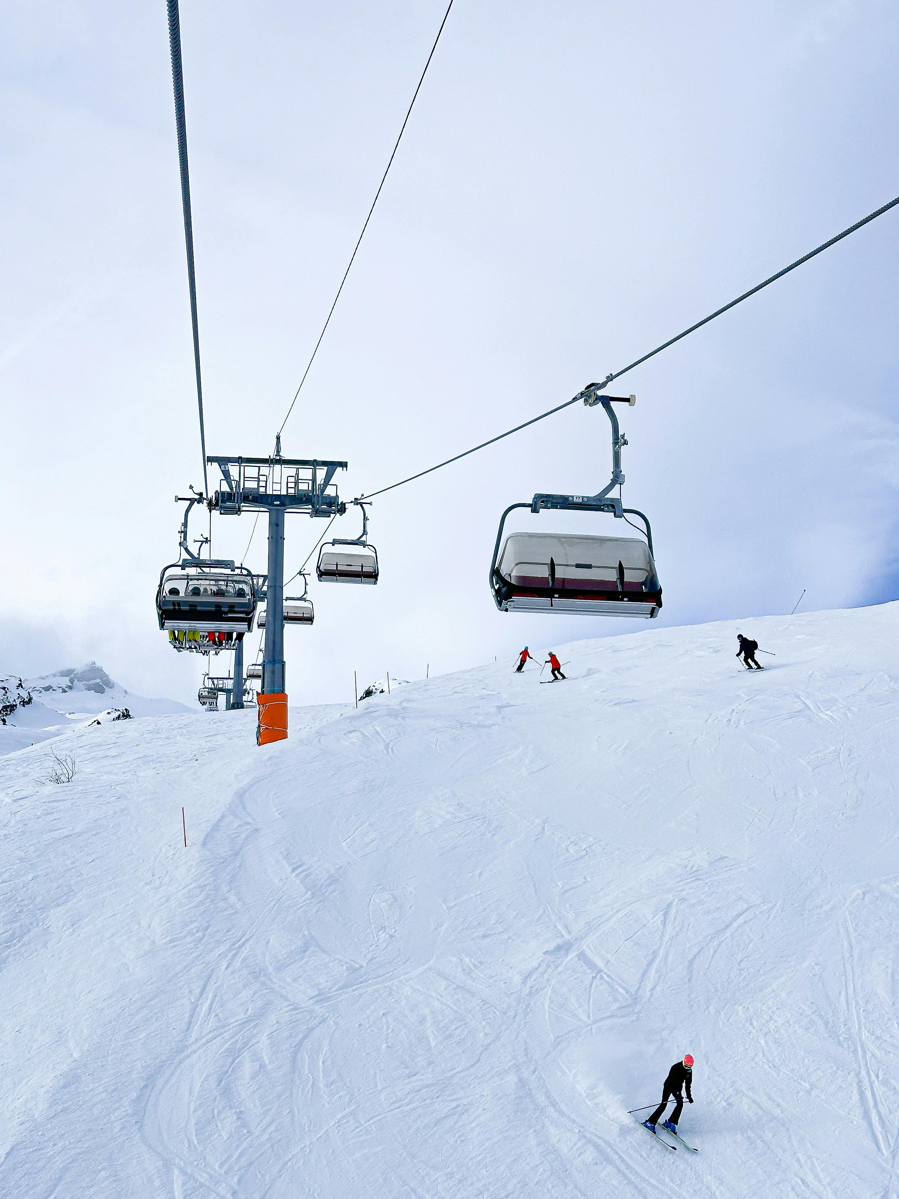 Skiers Descending Alpine Slopes in Switzerland · Free Stock Photo