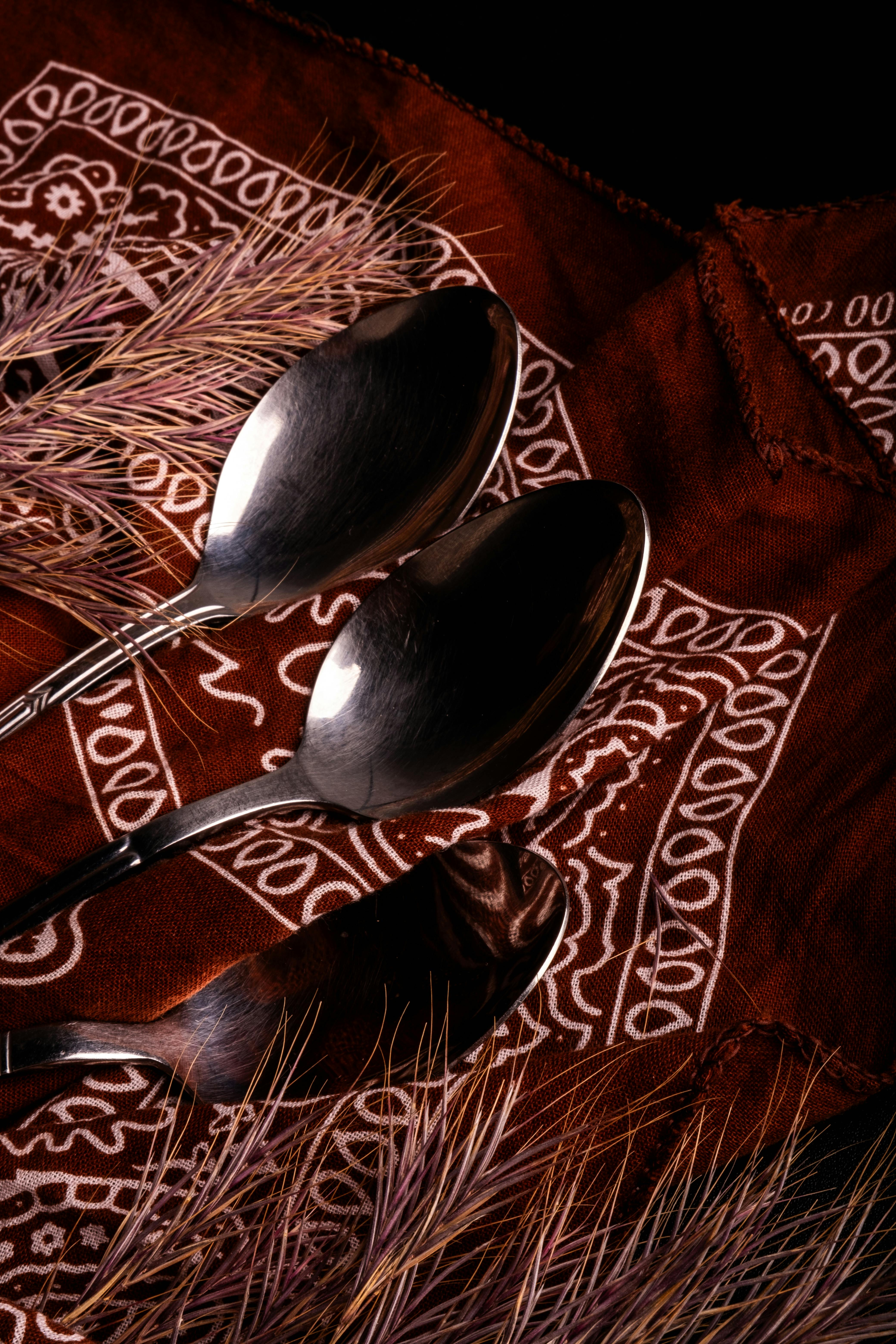 Artistic Still Life of Spoons on Patterned Fabric · Free Stock Photo