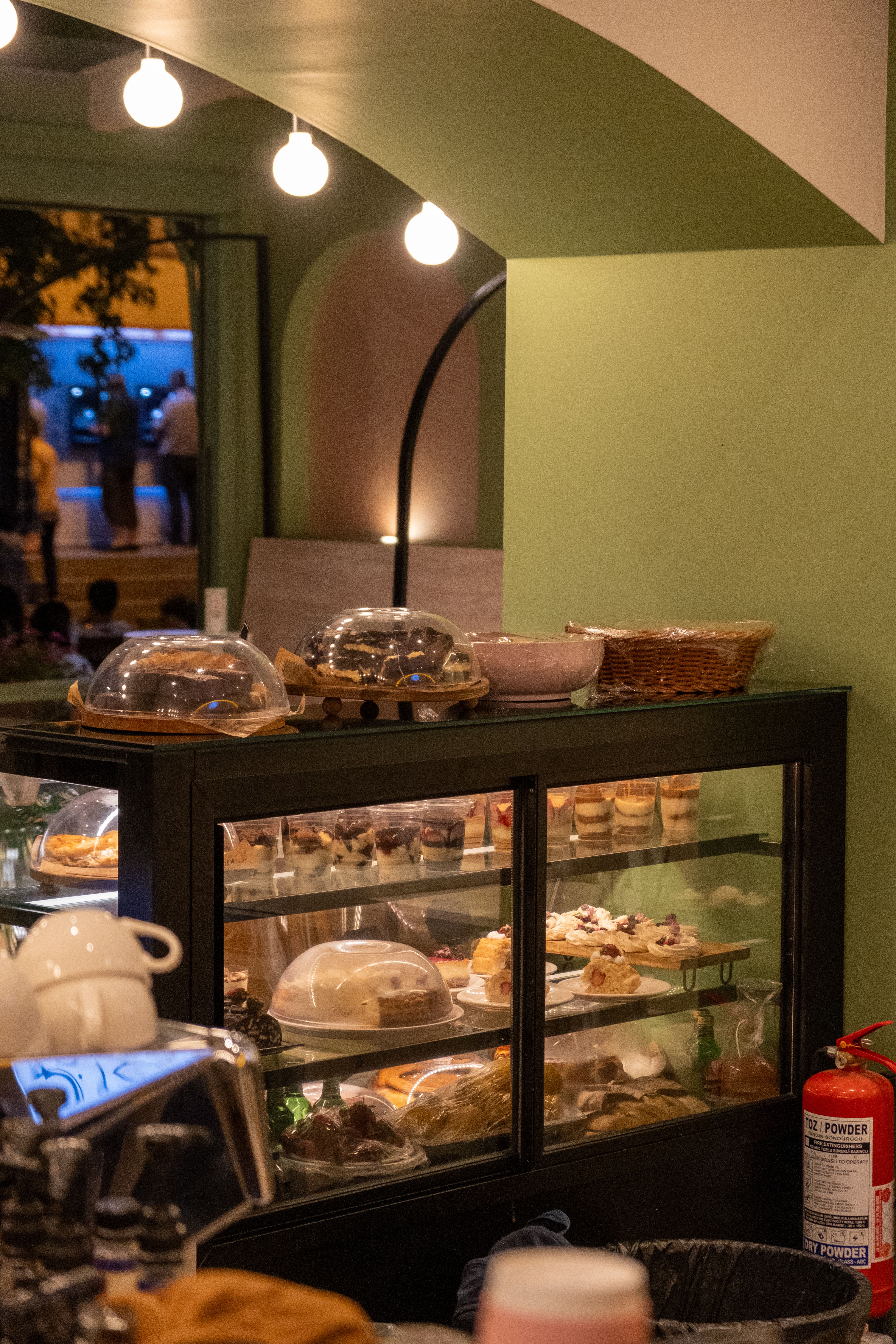 Cozy Cafe Interior with Display of Pastries · Free Stock Photo