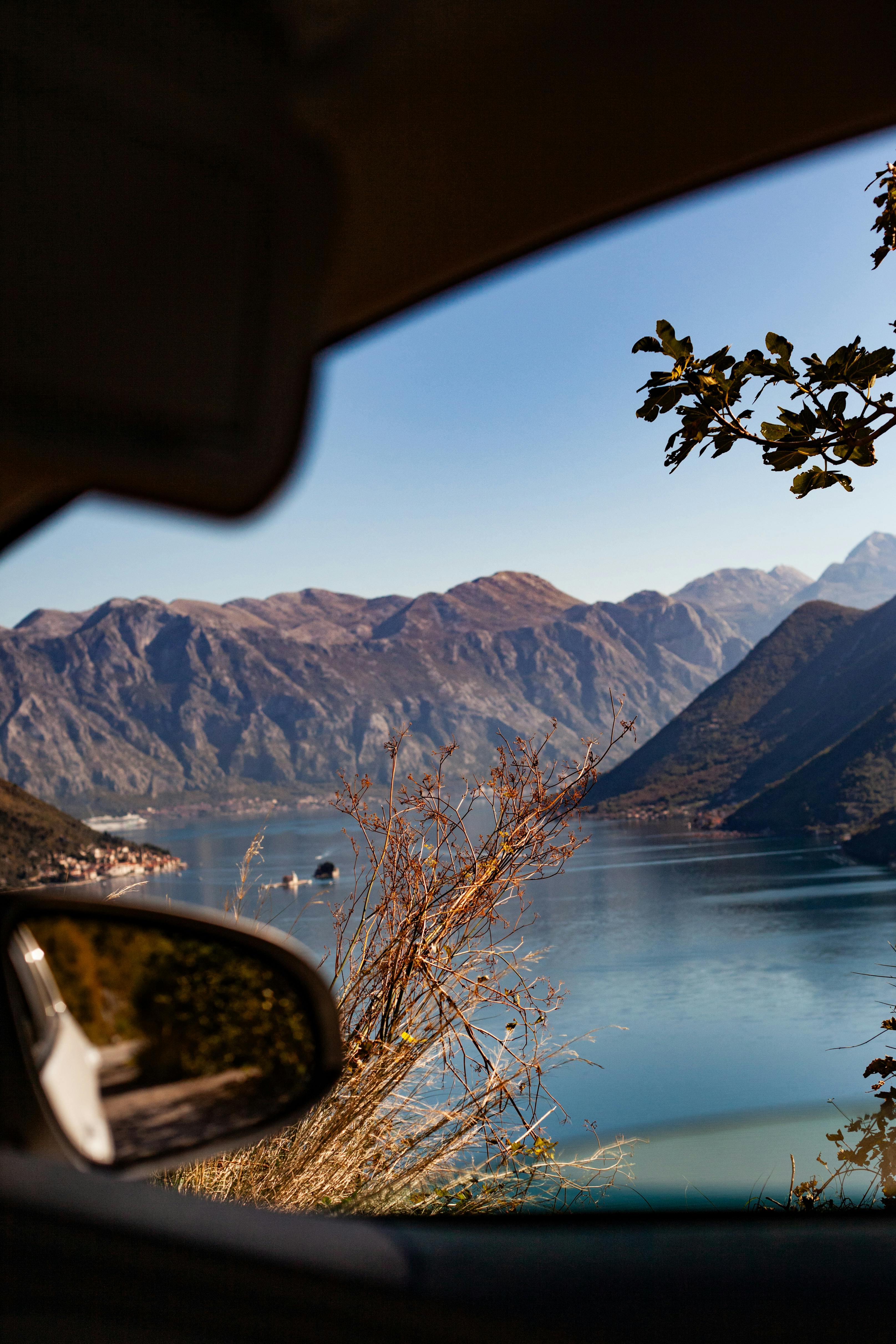 Scenic Mountain Lake View Through Car Window · Free Stock Photo
