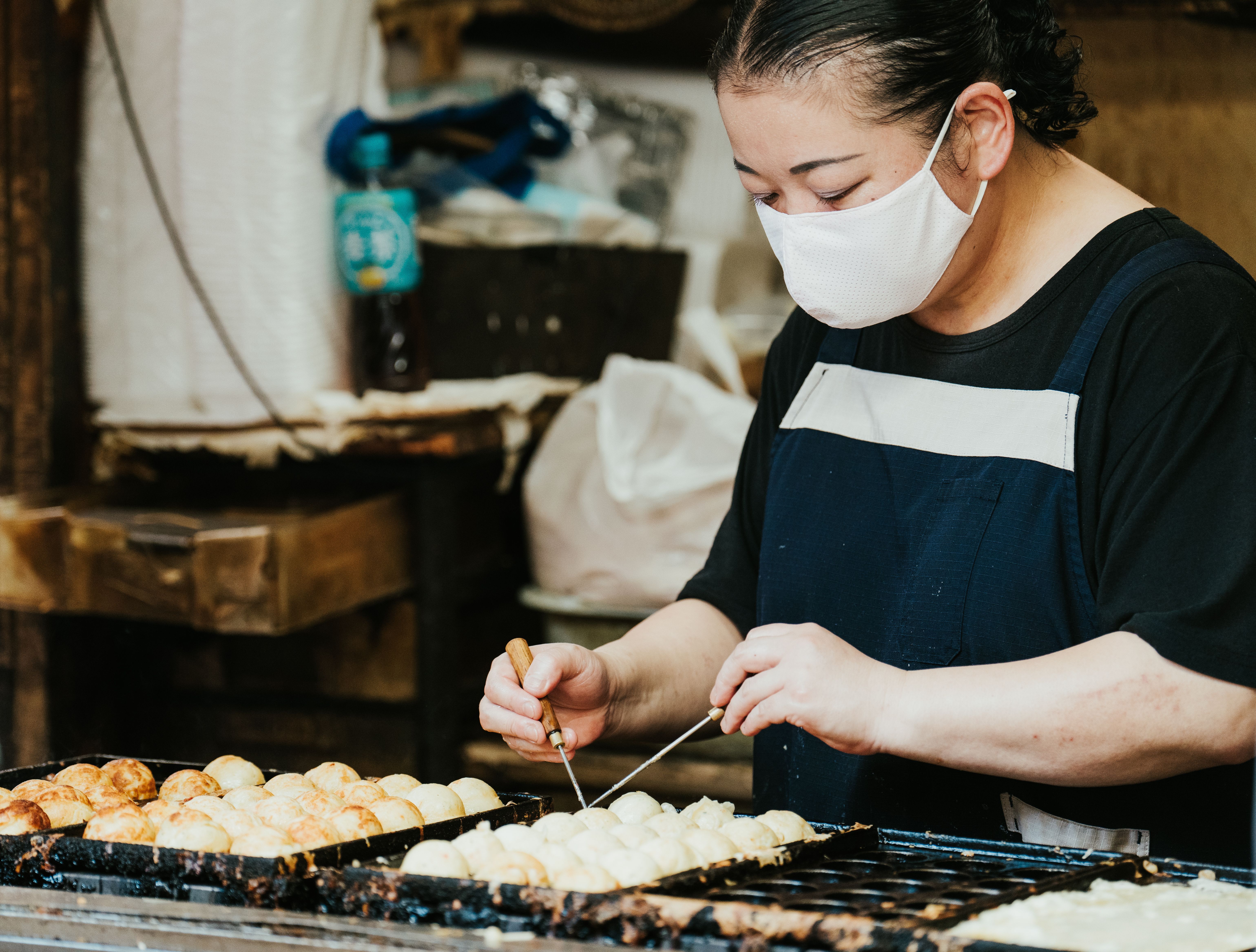 Traditional Japanese Street Food Vendor Cooking Takoyaki · Free Stock Photo