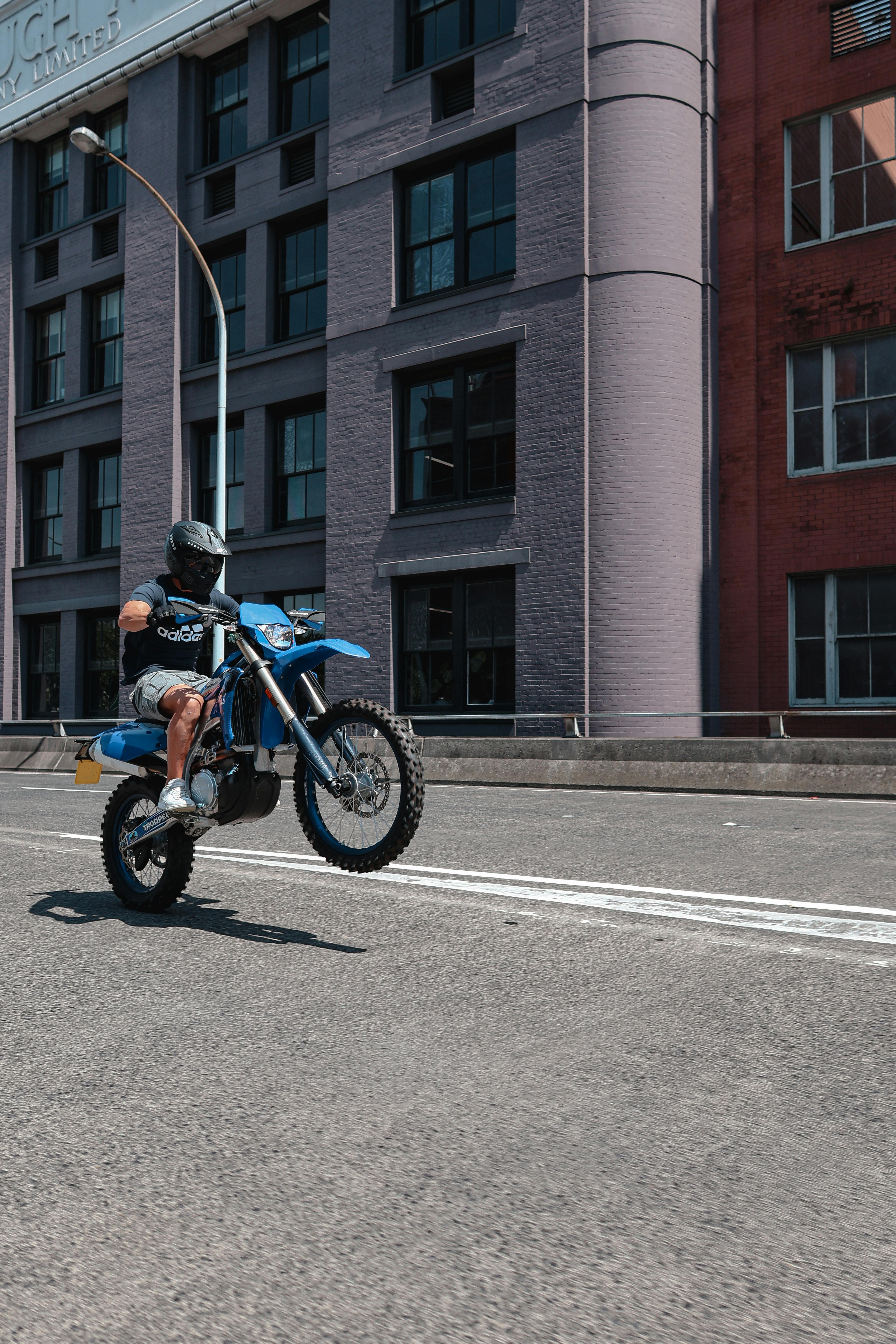 Urban Motorcycle Wheelie in City Street · Free Stock Photo