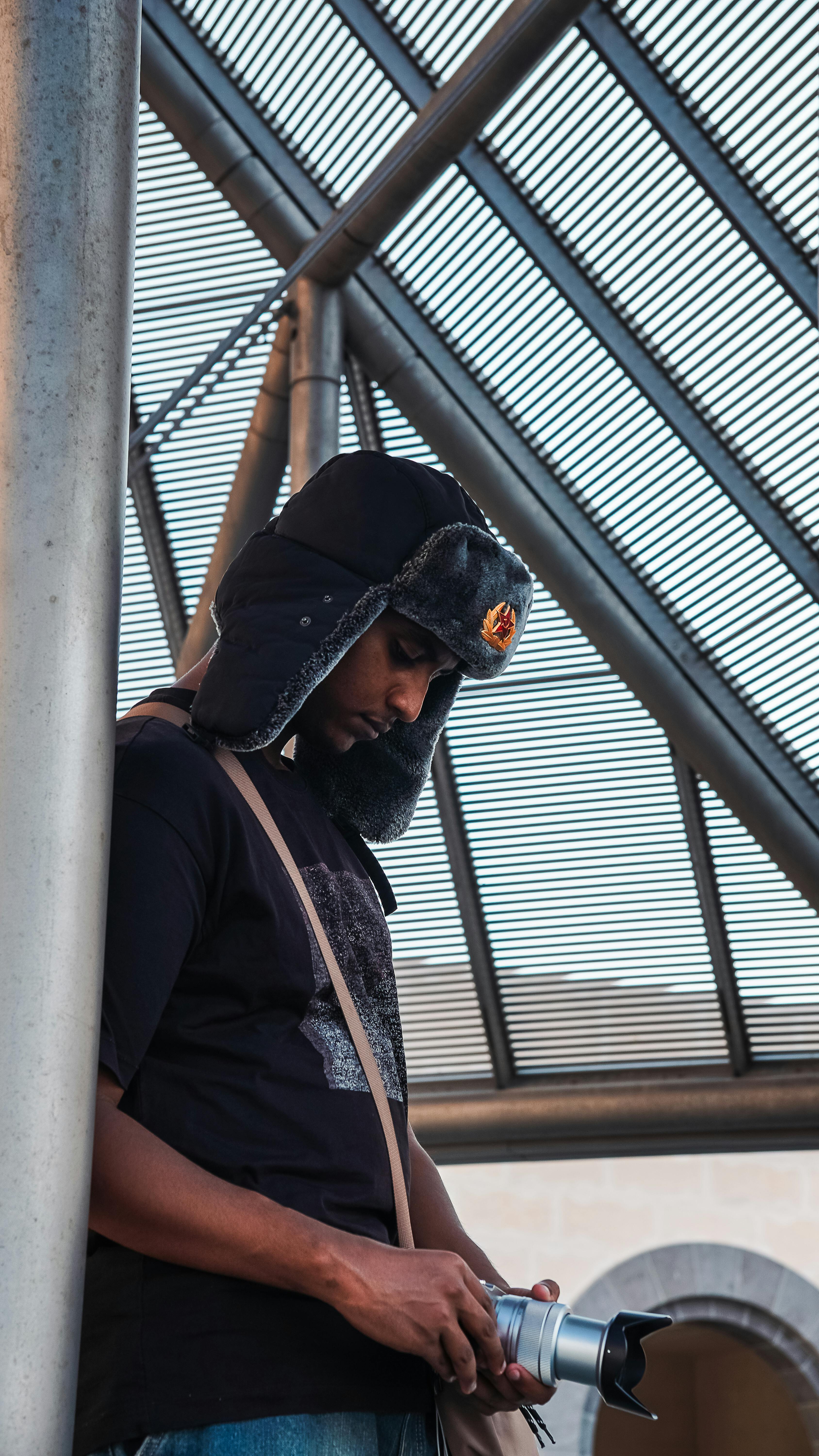 Man in Winter Hat with Camera in Doha · Free Stock Photo