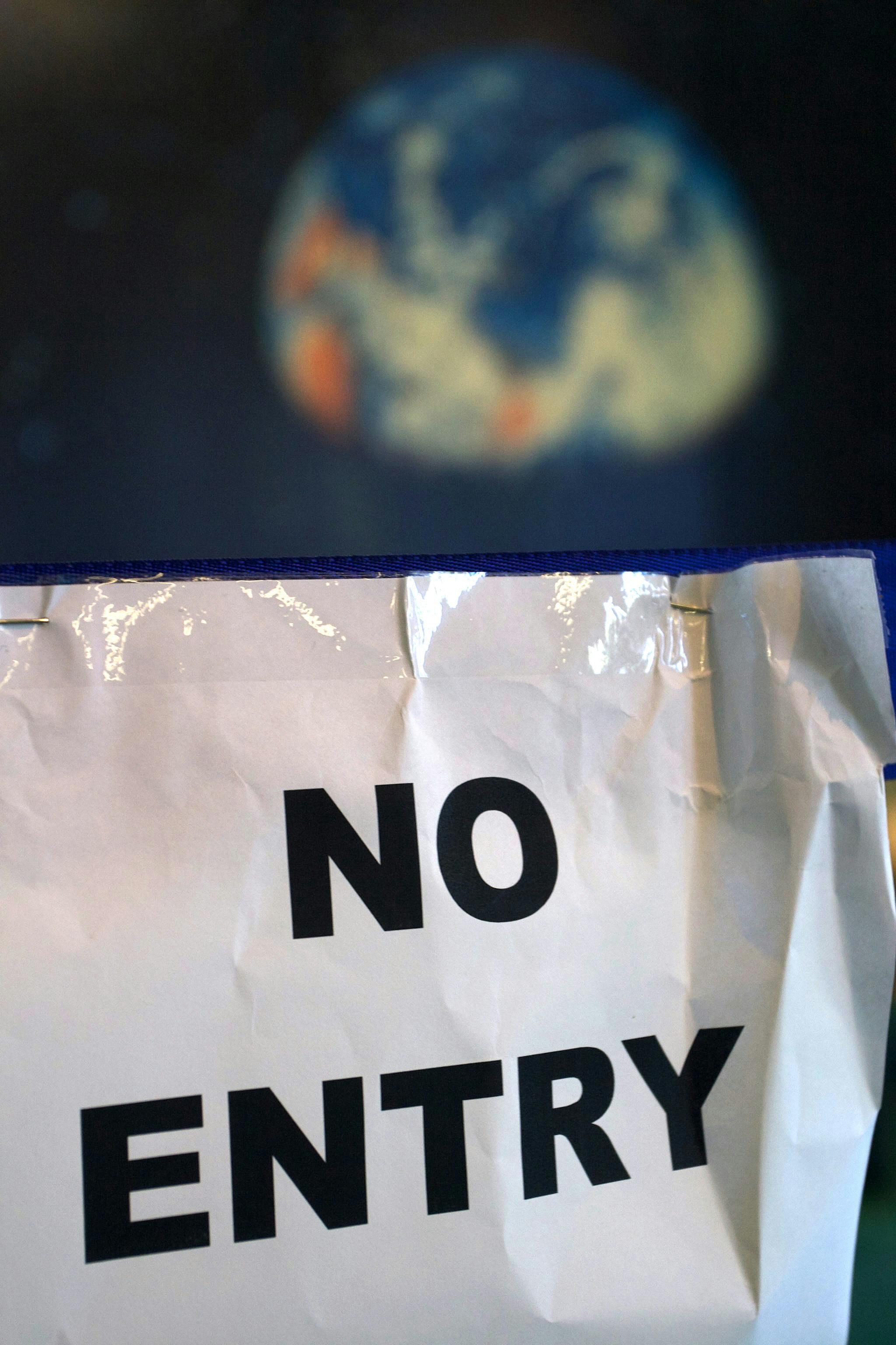 No Entry Sign with Blurred Globe Backdrop · Free Stock Photo