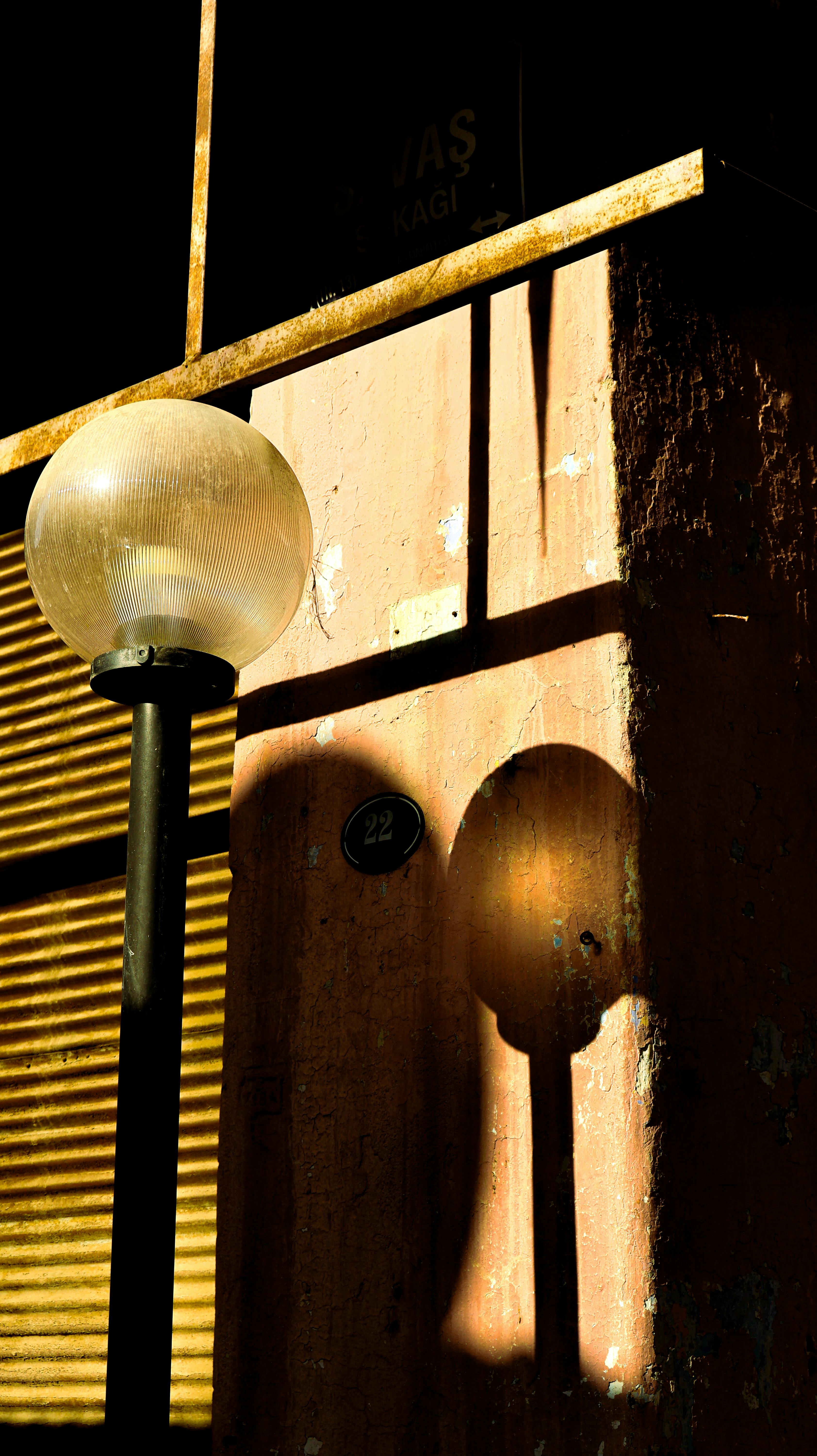 Dramatic Streetlight Shadow on Urban Wall · Free Stock Photo