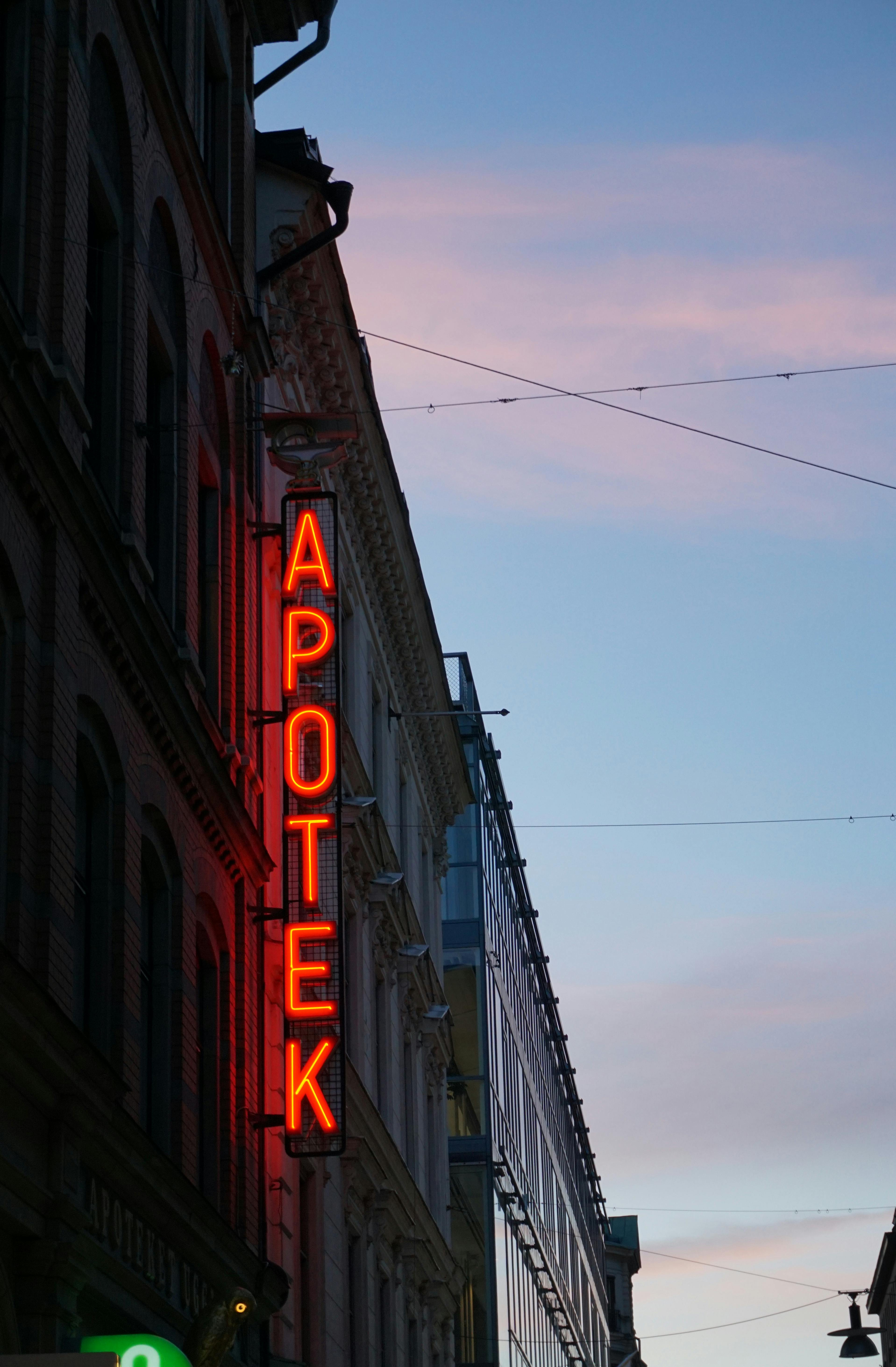 Neon Apotek Sign in Stockholm Cityscape · Free Stock Photo