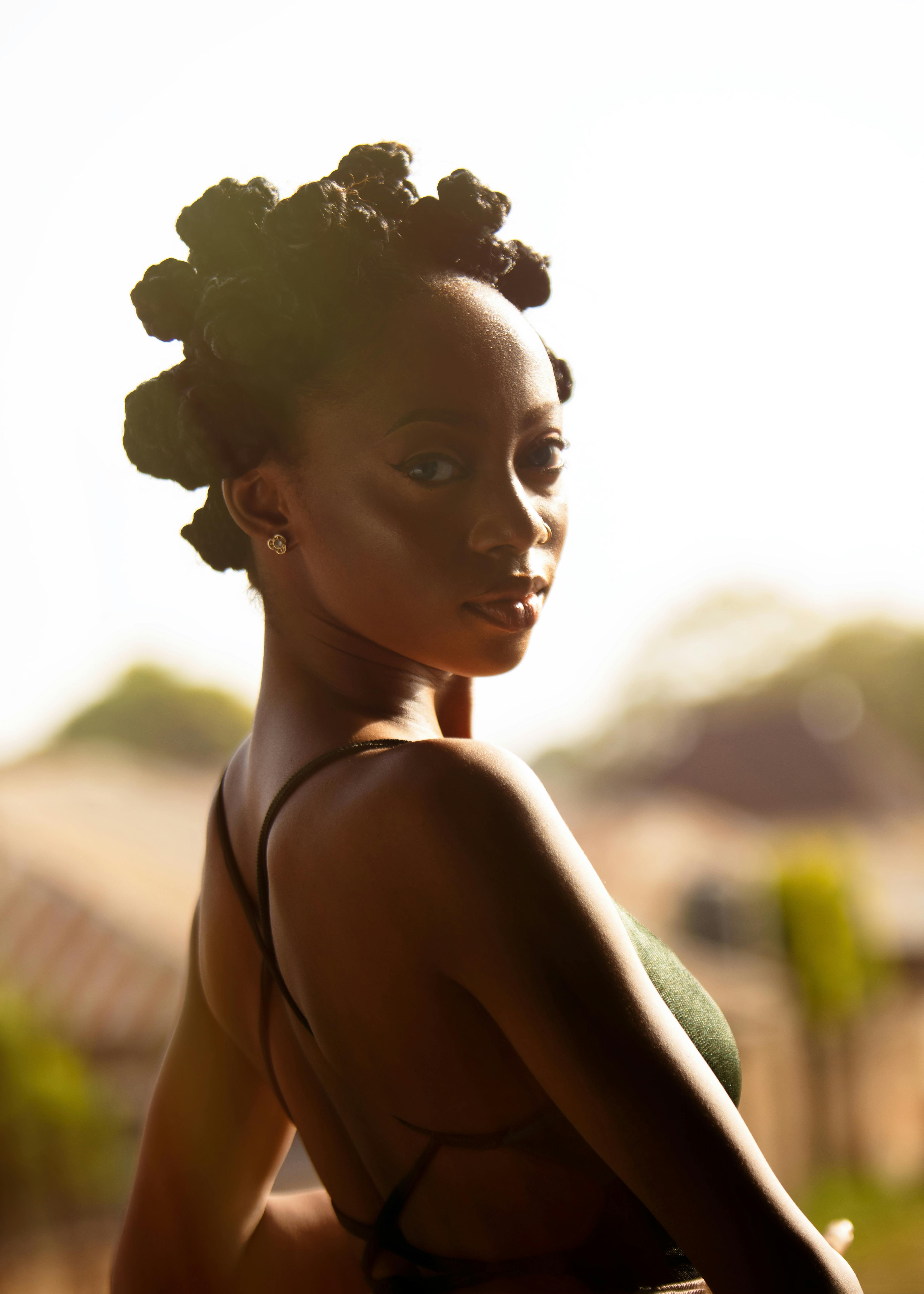 Backlit Portrait of Woman with Natural Hair Outdoors · Free Stock Photo