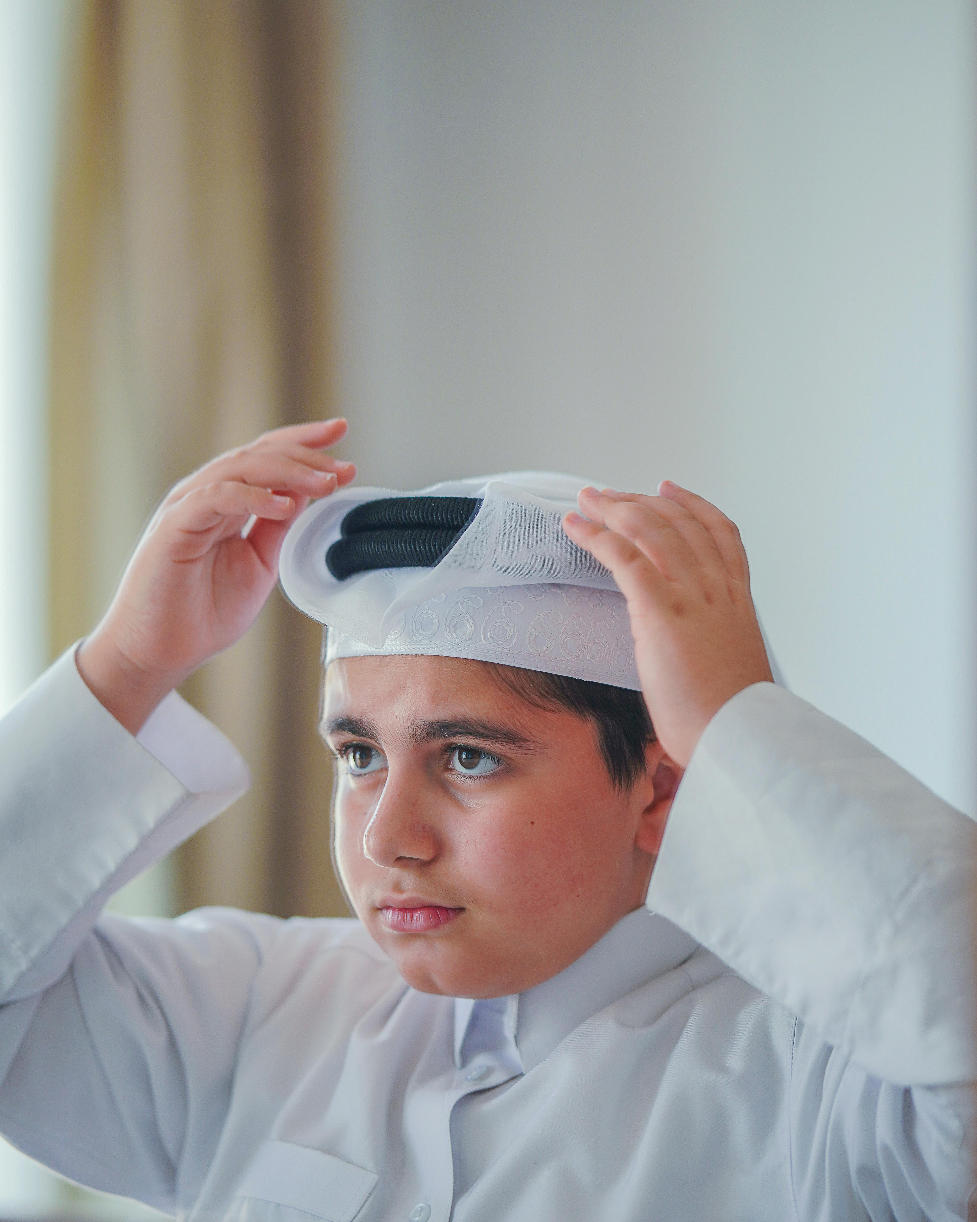 Young Boy in Traditional Qatari Attire · Free Stock Photo