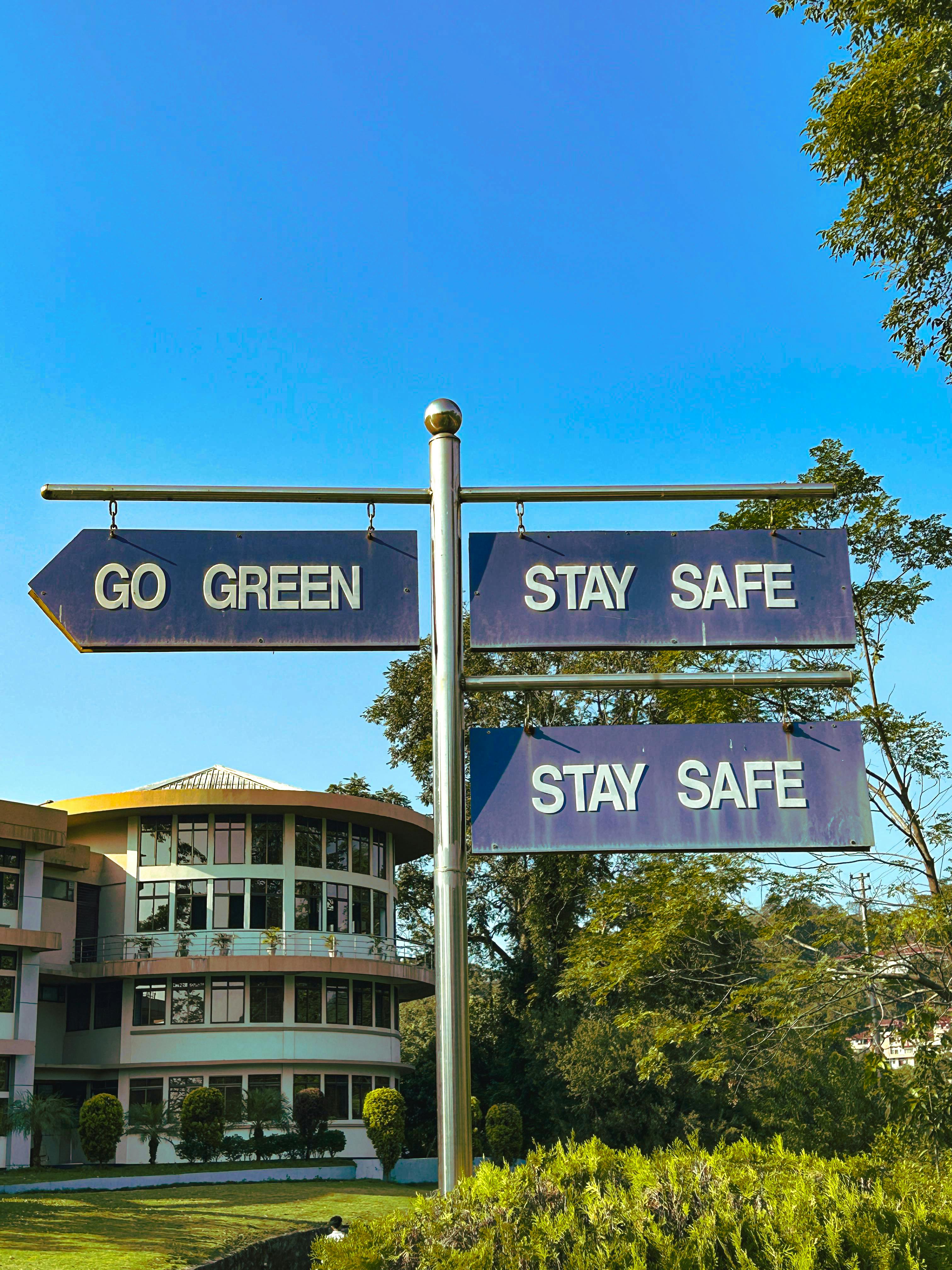 Directional Sign with Environmental Message Outdoors · Free Stock Photo