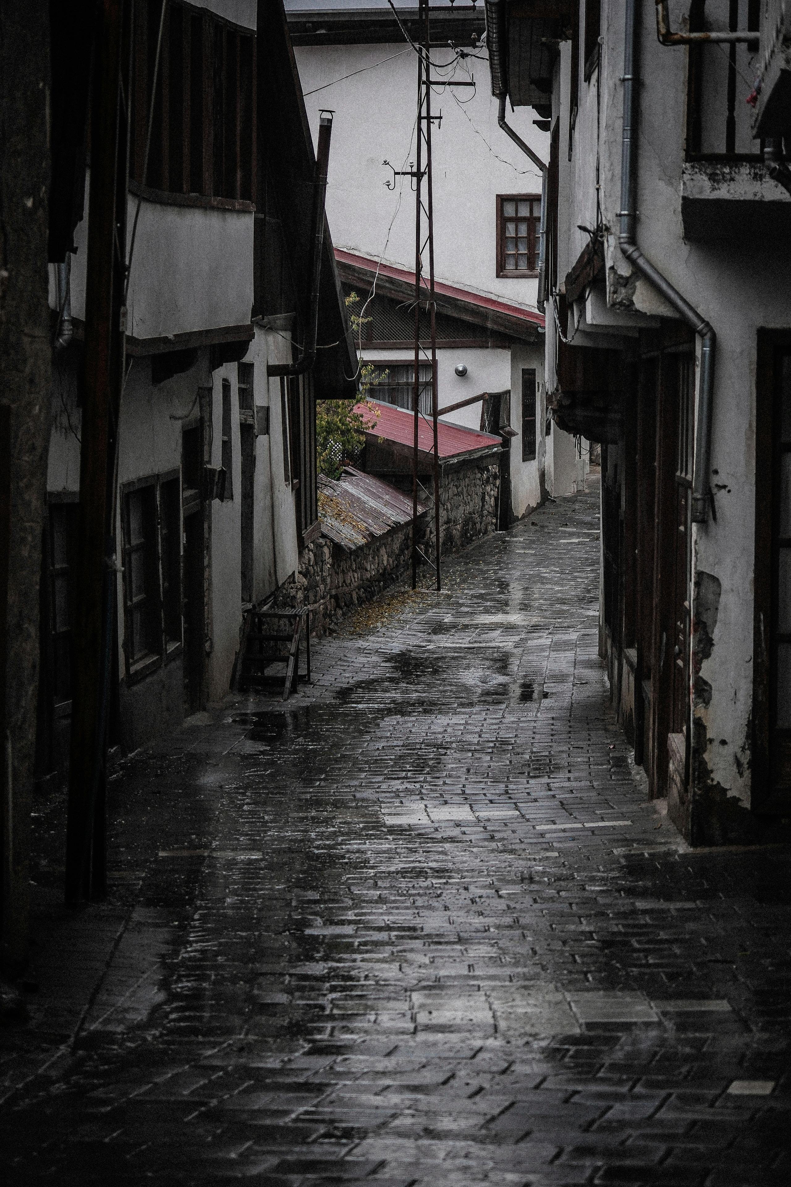 Moody Rain-soaked Alley in Historic Neighborhood · Free Stock Photo