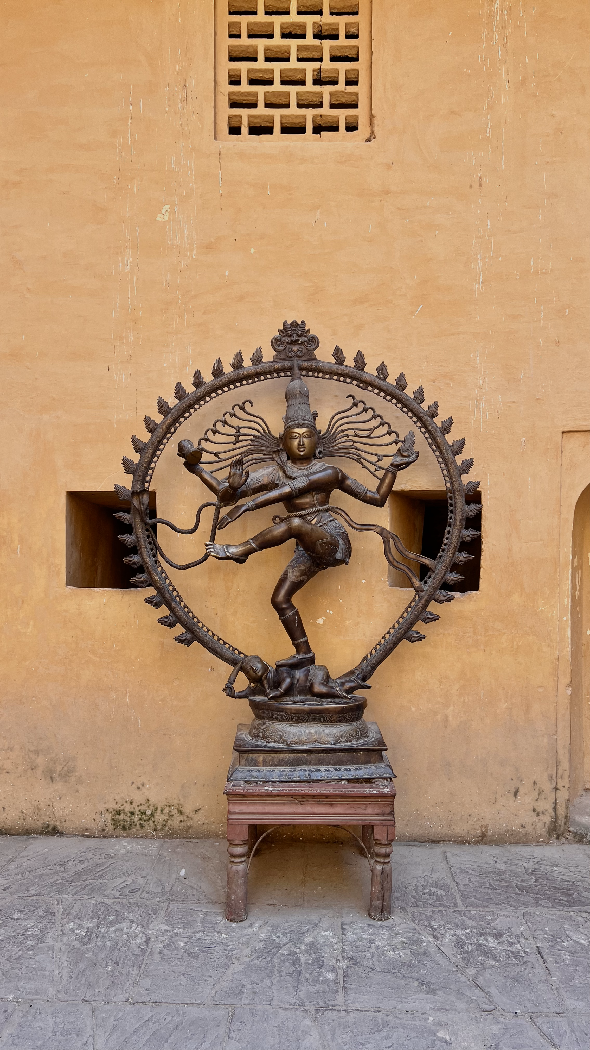 Copper Nataraja Statue Against Historic Wall · Free Stock Photo