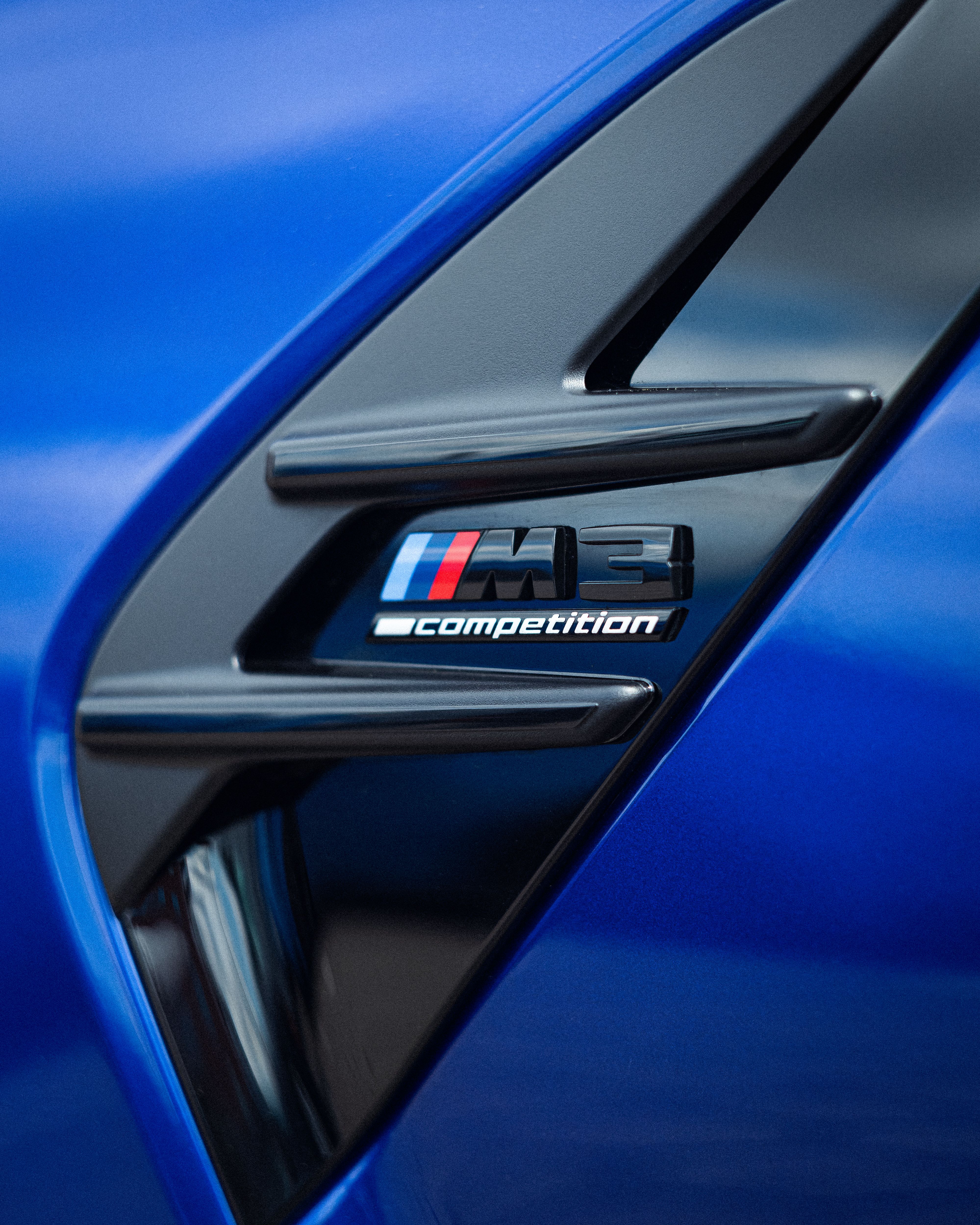 Close-Up of Blue BMW M3 Competition Badge · Free Stock Photo