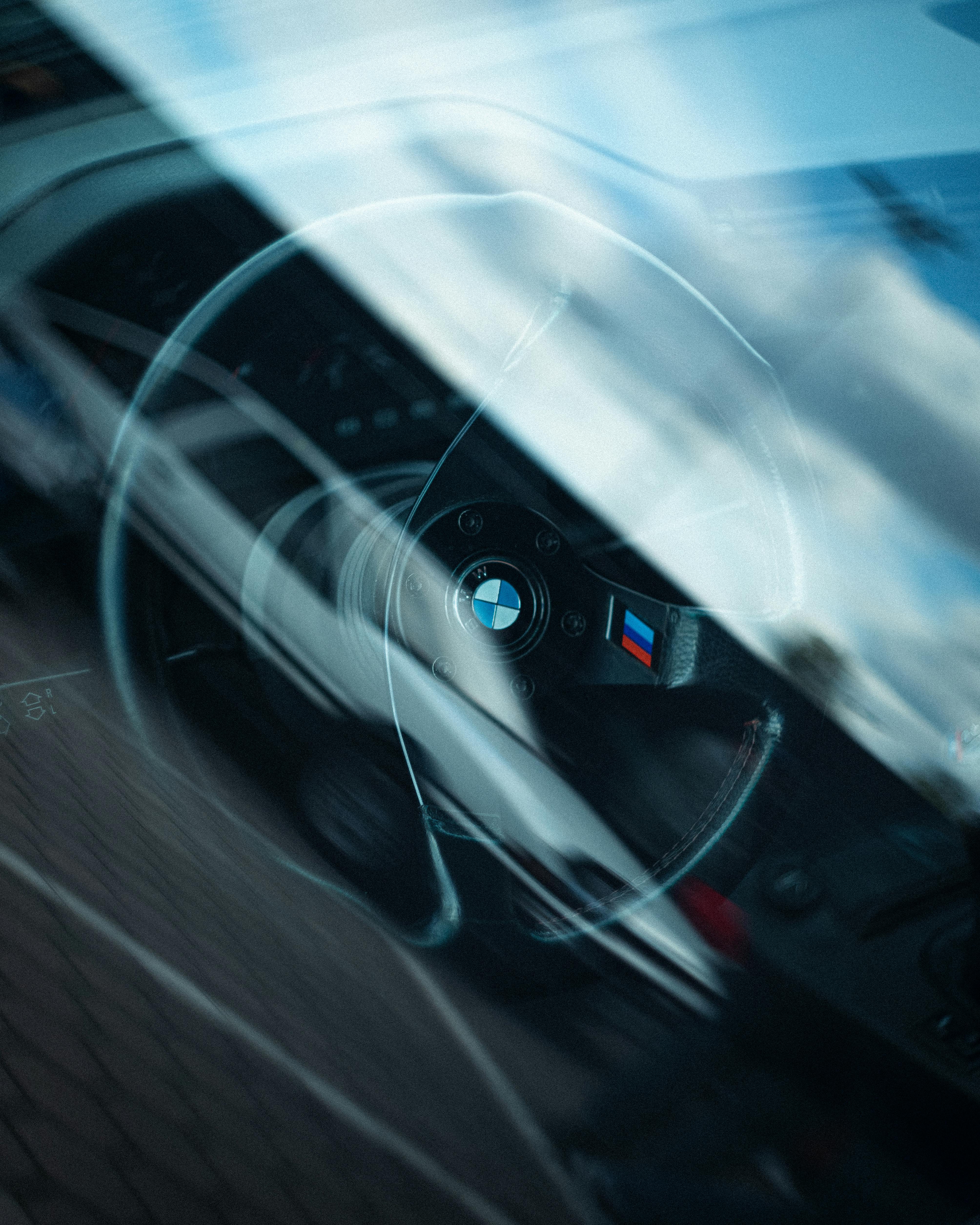 BMW Steering Wheel Through Car Window Reflection · Free Stock Photo
