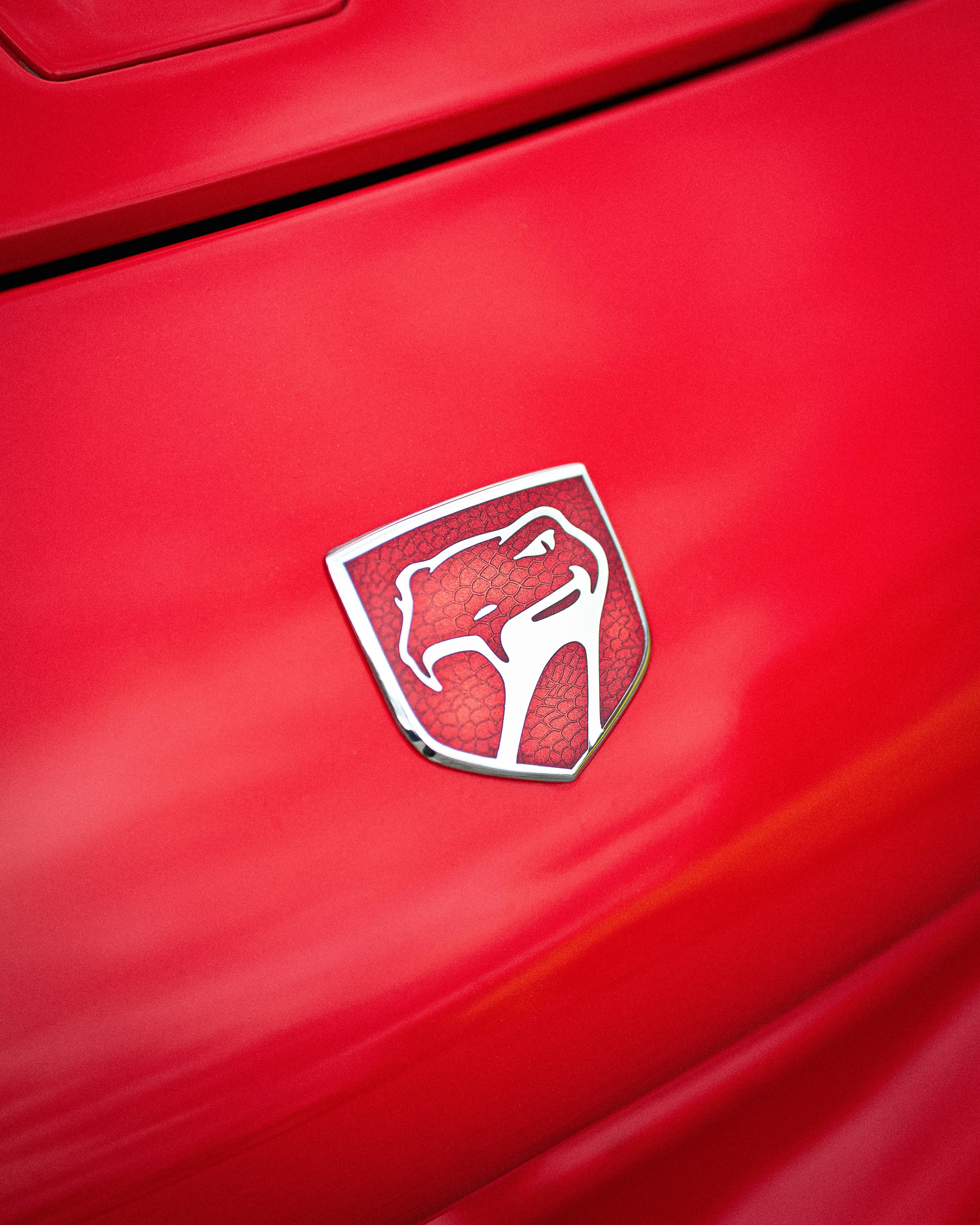 Close-up of Red Dodge Viper Emblem on Car · Free Stock Photo