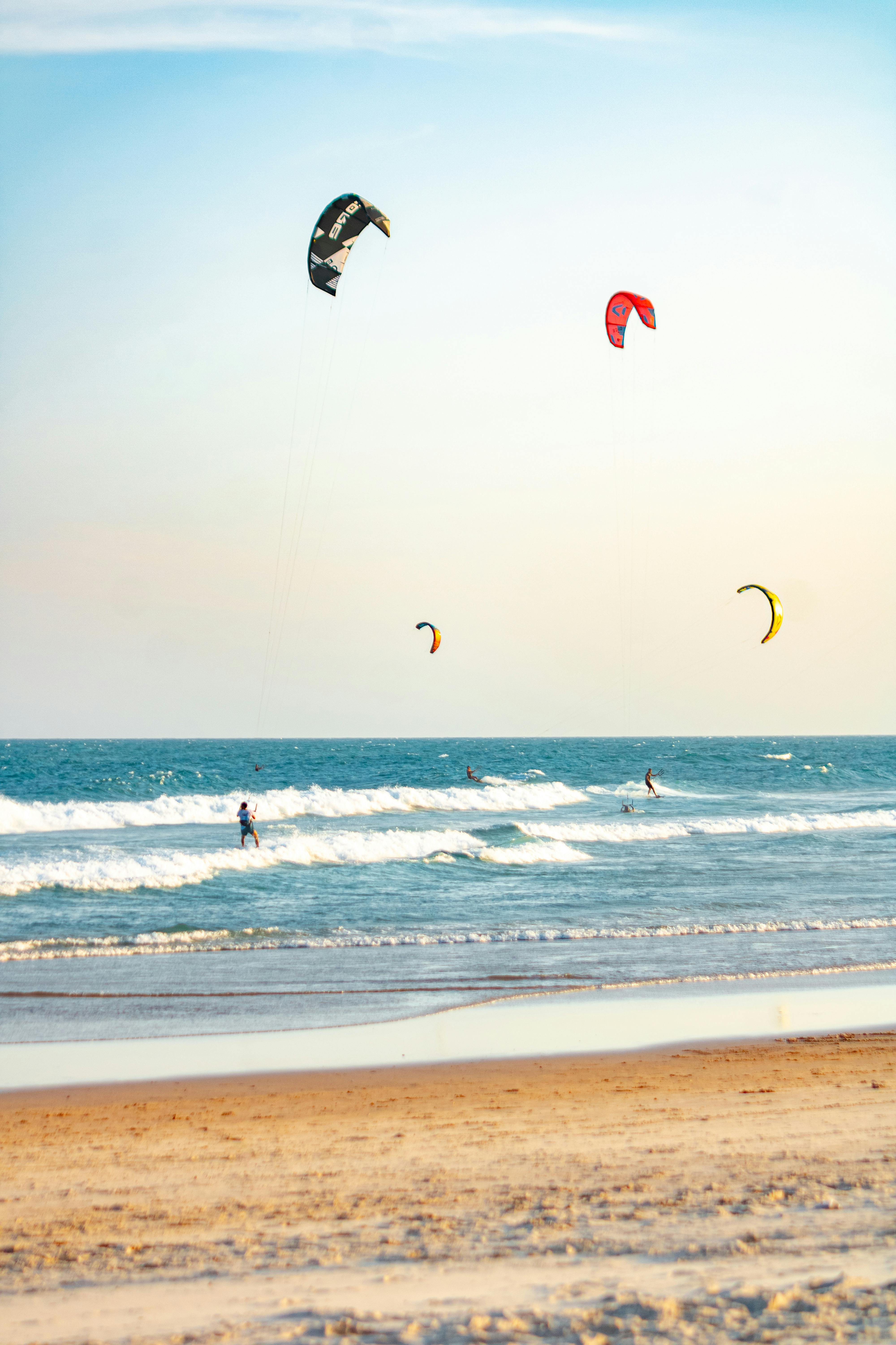 Kitesurfers Enjoying a Sunny Day at the Beach · Free Stock Photo