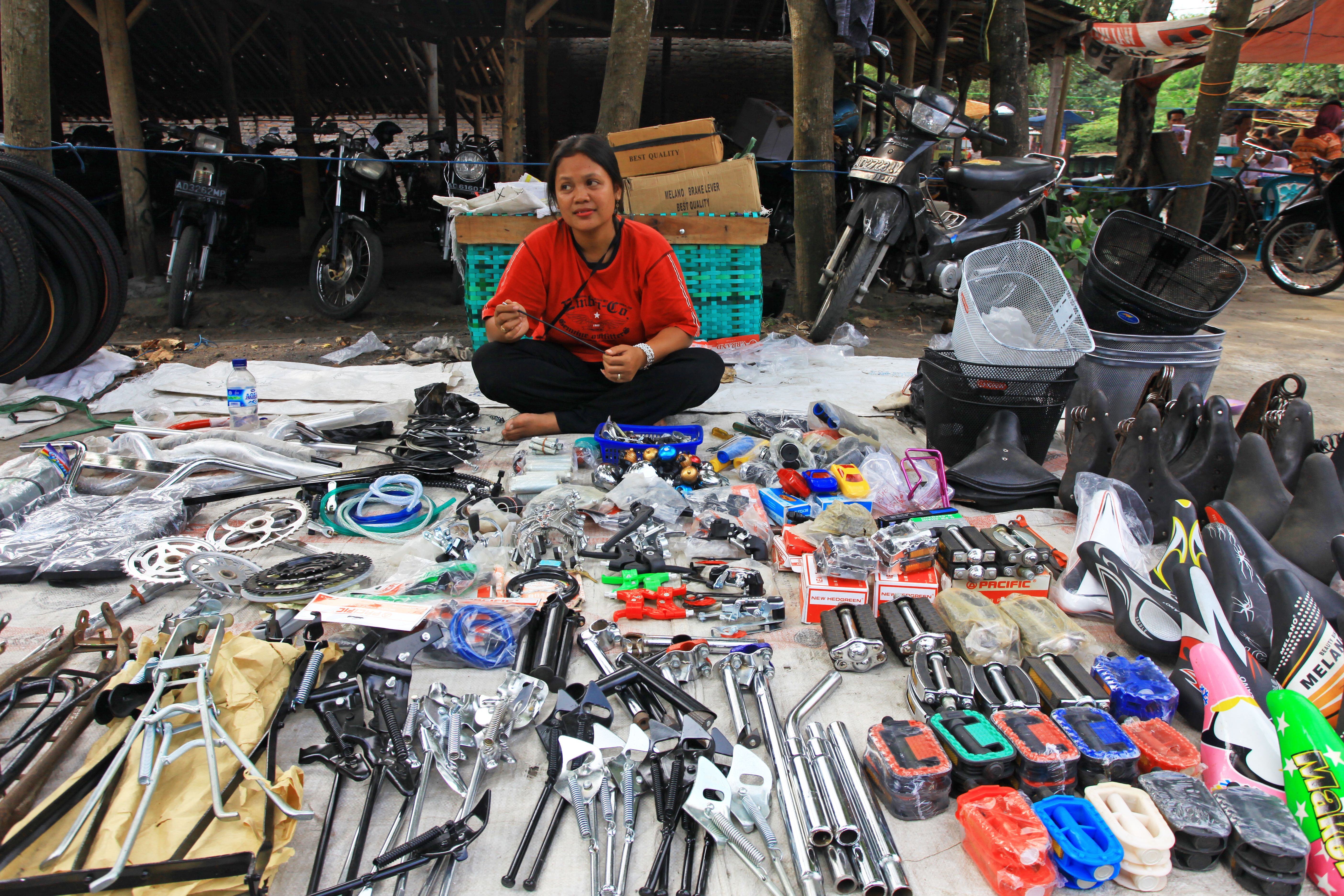 Street Vendor Selling Motorcycle Parts Outdoors · Free Stock Photo